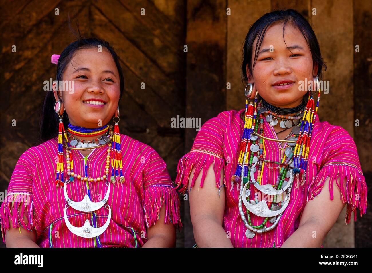 Two Young Women From The Kayaw Ethnic Group Sitting Down Outside Their ...