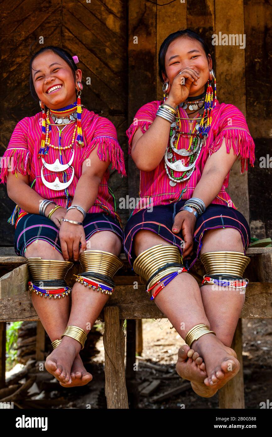 Two Young Women From The Kayaw Ethnic Group Sitting Down Outside Their ...