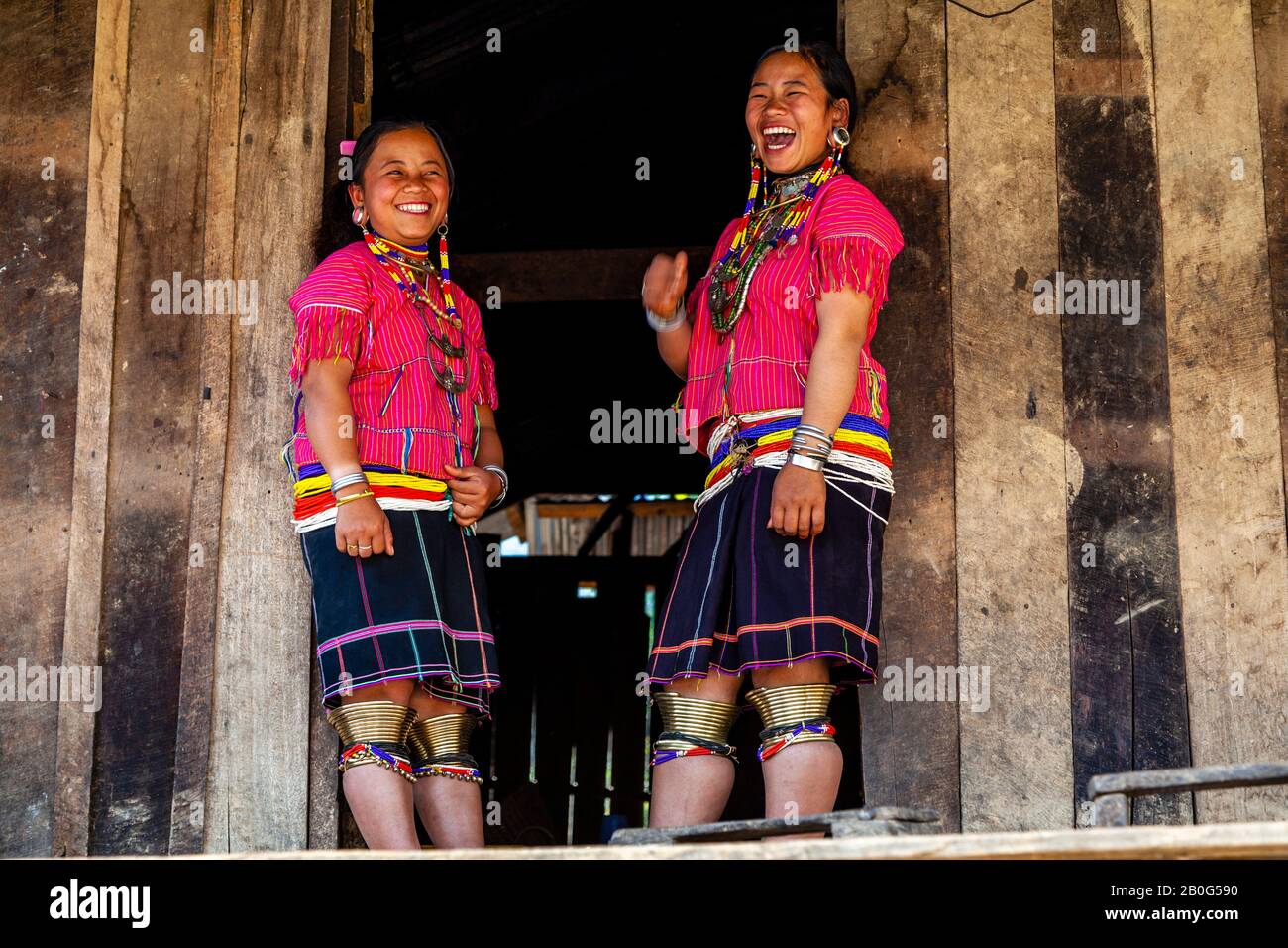 Two Young Women From The Kayaw Ethnic Group Standing Outside Their ...