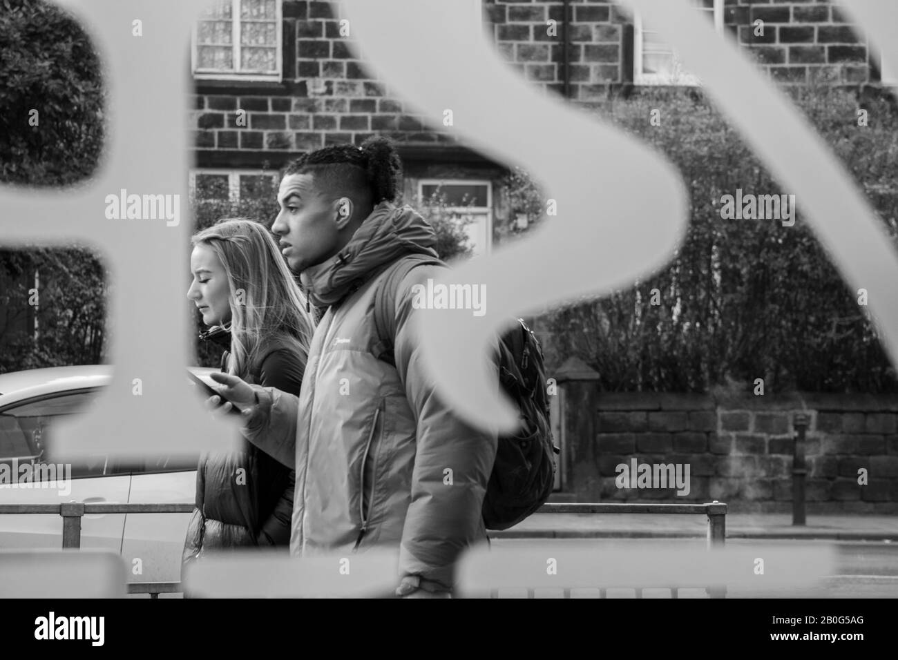 People passing in front of the window front of a shop Stock Photo - Alamy