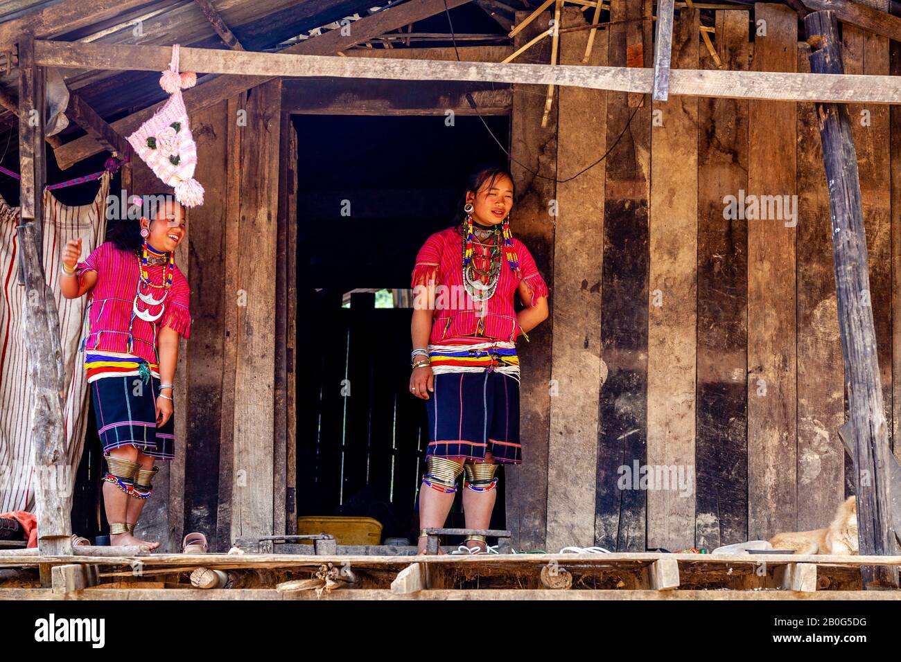 Two Young Women From The Kayaw Ethnic Group Standing Outside Their ...