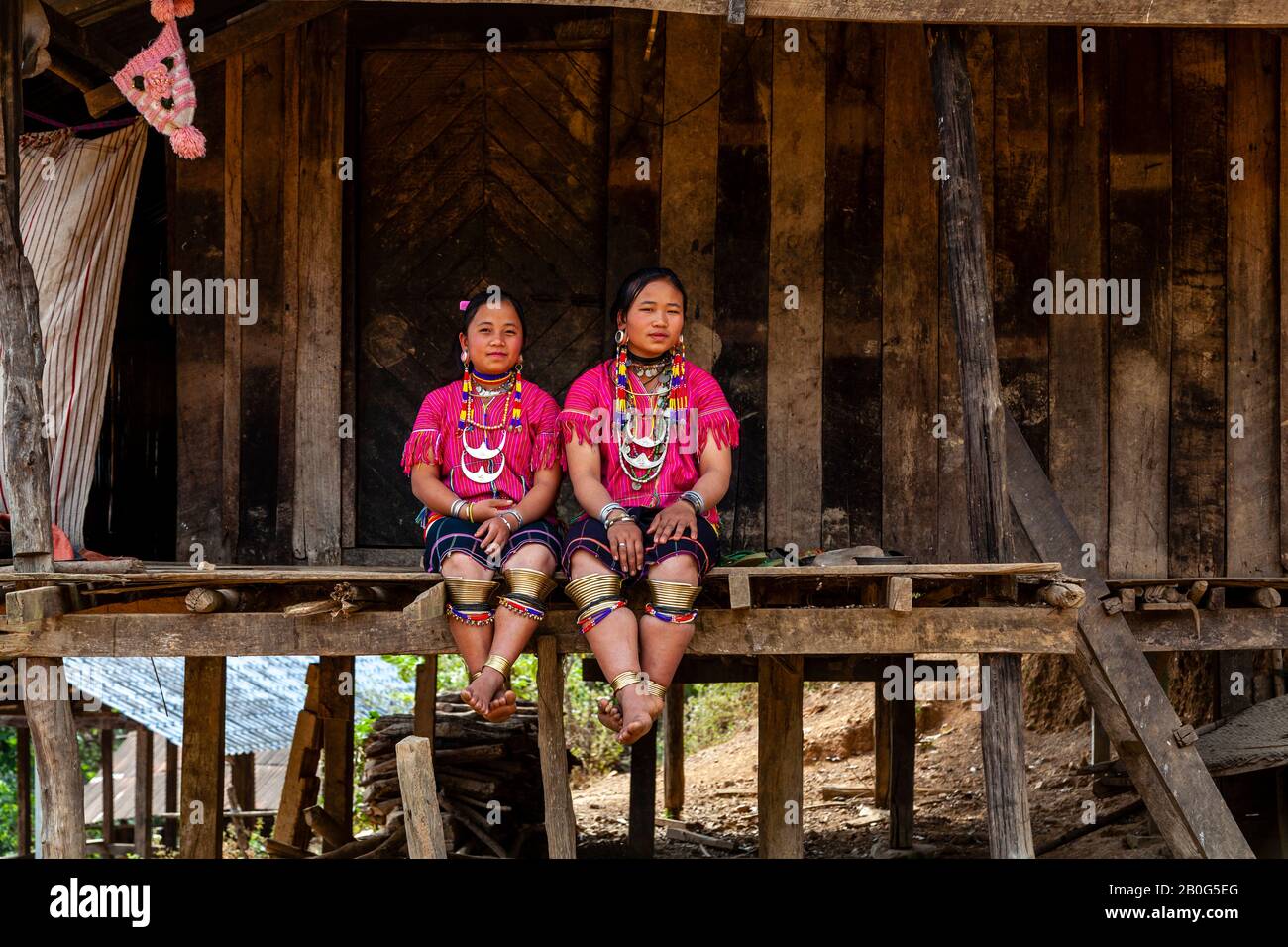 Two Young Women From The Kayaw Ethnic Group Sitting Down Outside Their ...
