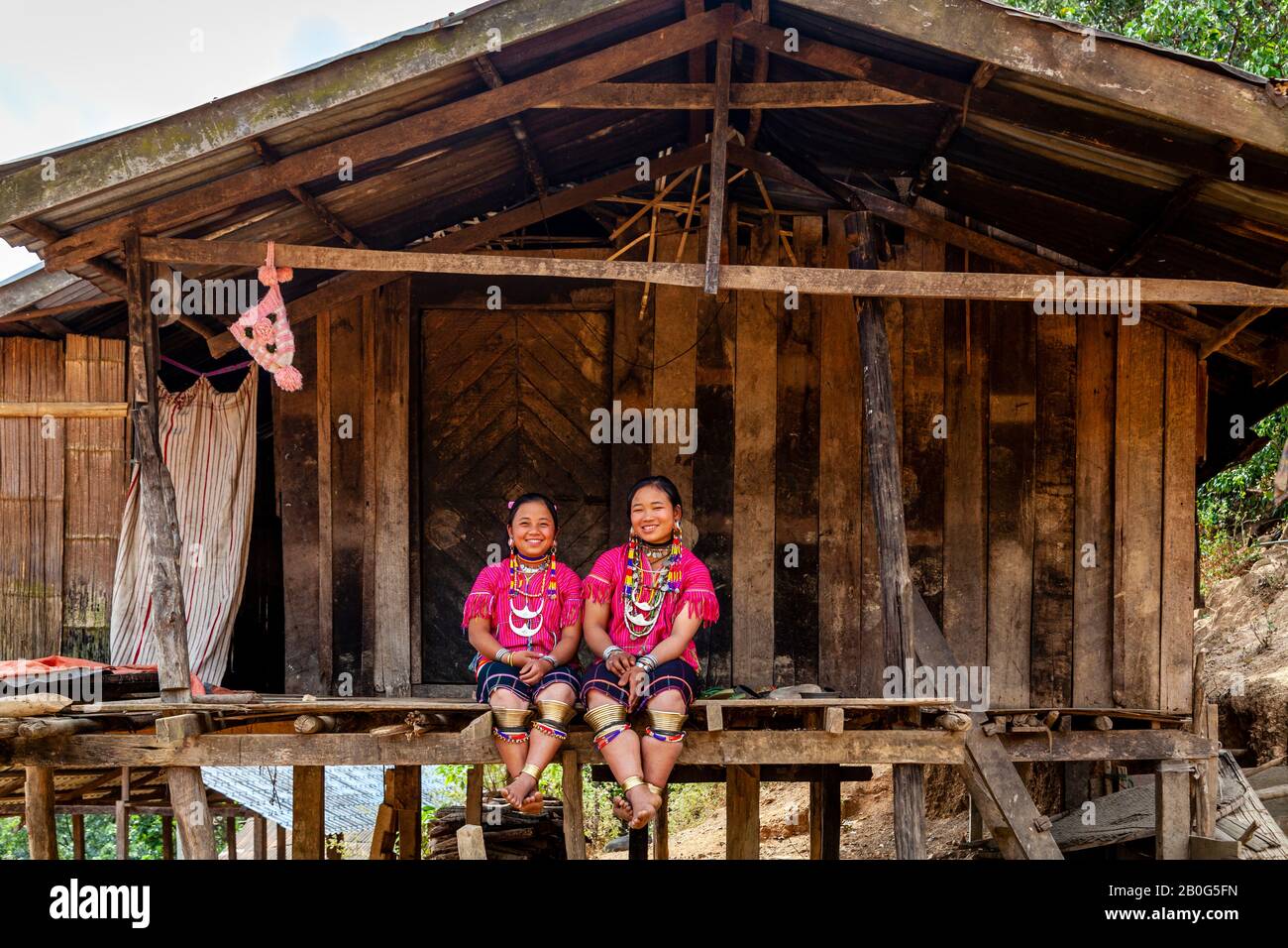 Two Young Women From The Kayaw Ethnic Group Sitting Down Outside Their ...