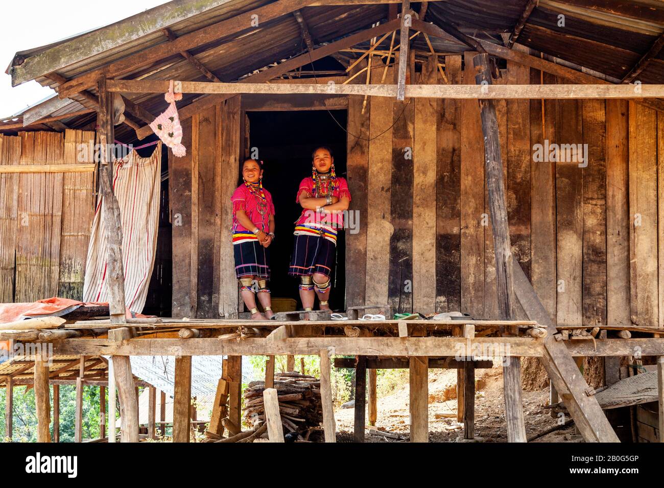 Two Young Women From The Kayaw Ethnic Group Standing Outside Their ...