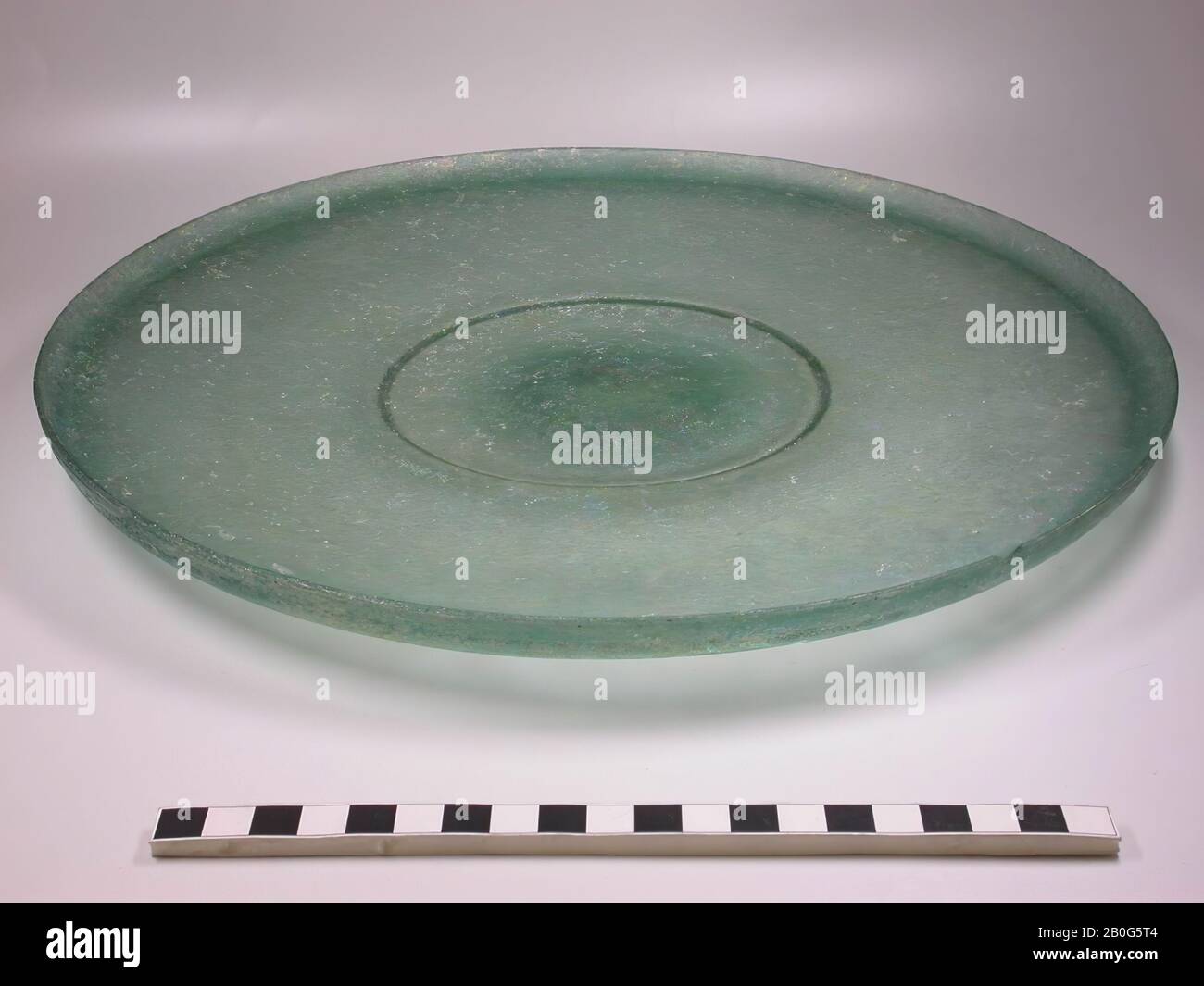 Roman scale of blue-green glass. Flat model with low edge and stand ...