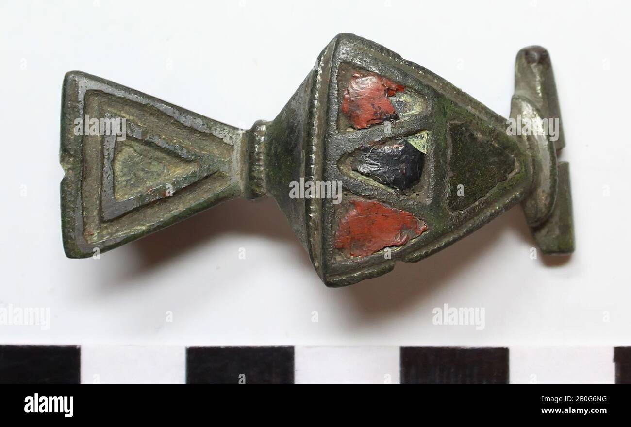 Fibula of bronze, composed of two triangles inlaid with red enamel and ...