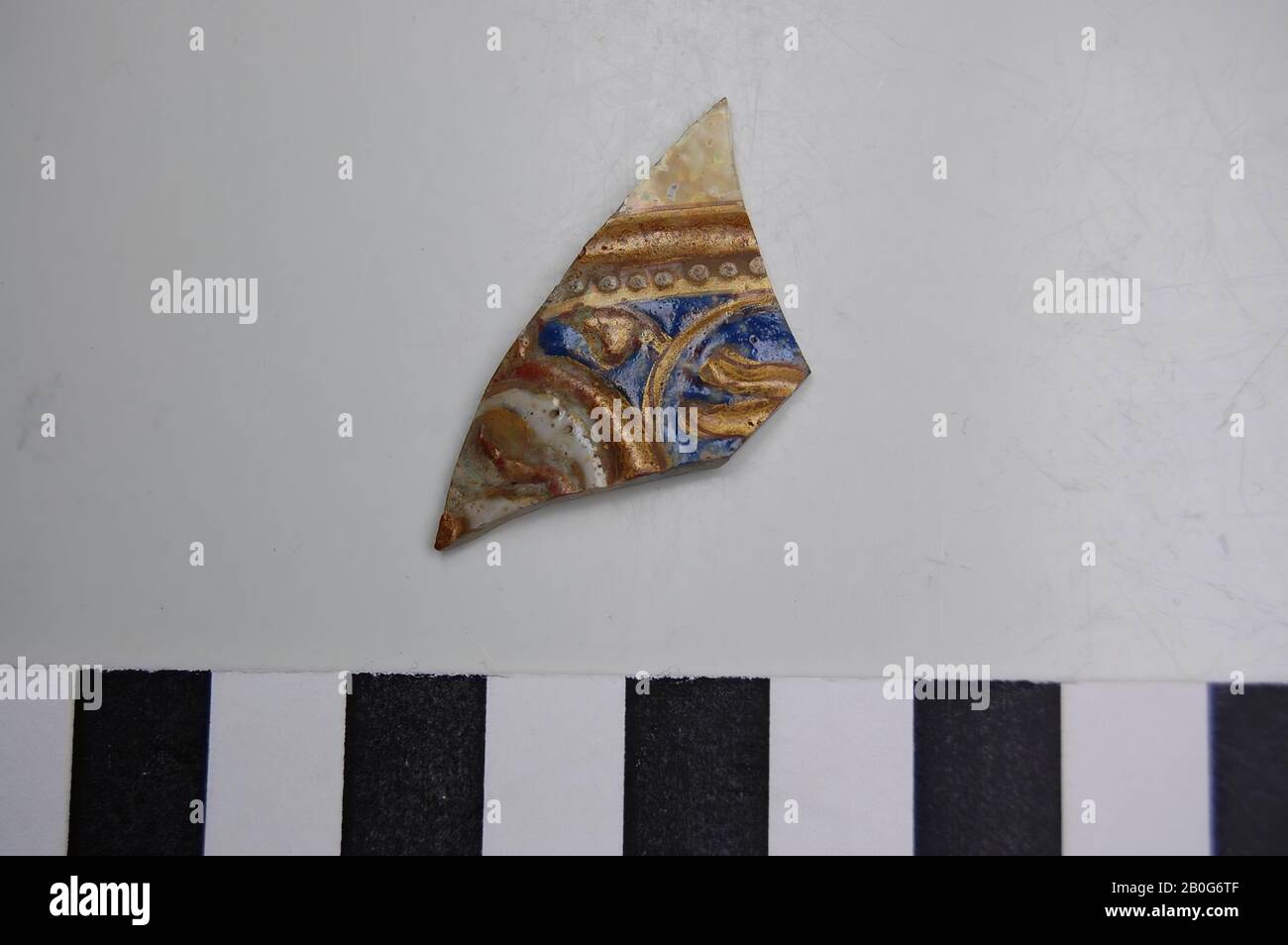 Glass shard with decoration in relief, decorated with blue, red and ...