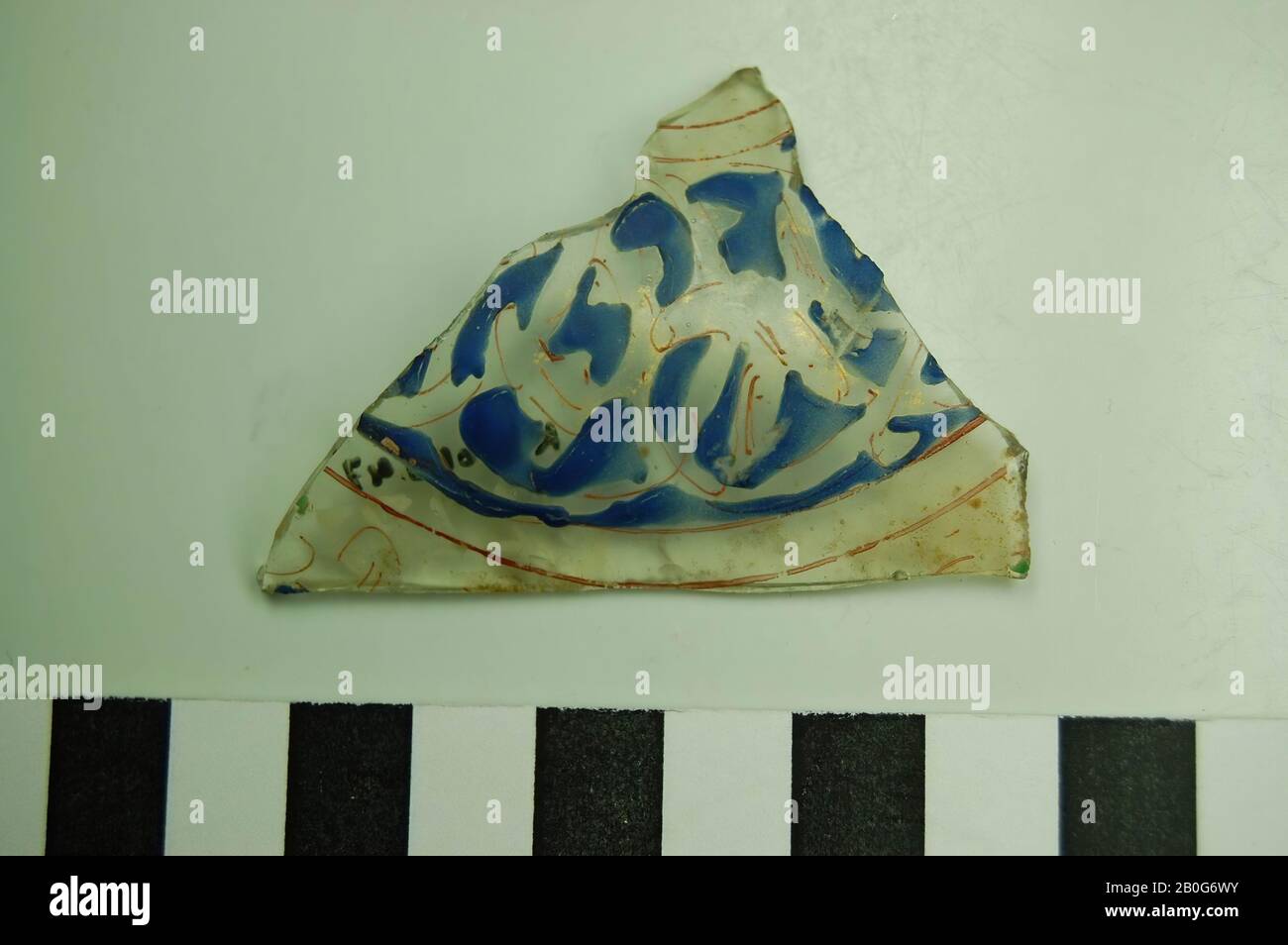 Glass shard with the colors red, blue and gold. In the glass air ...