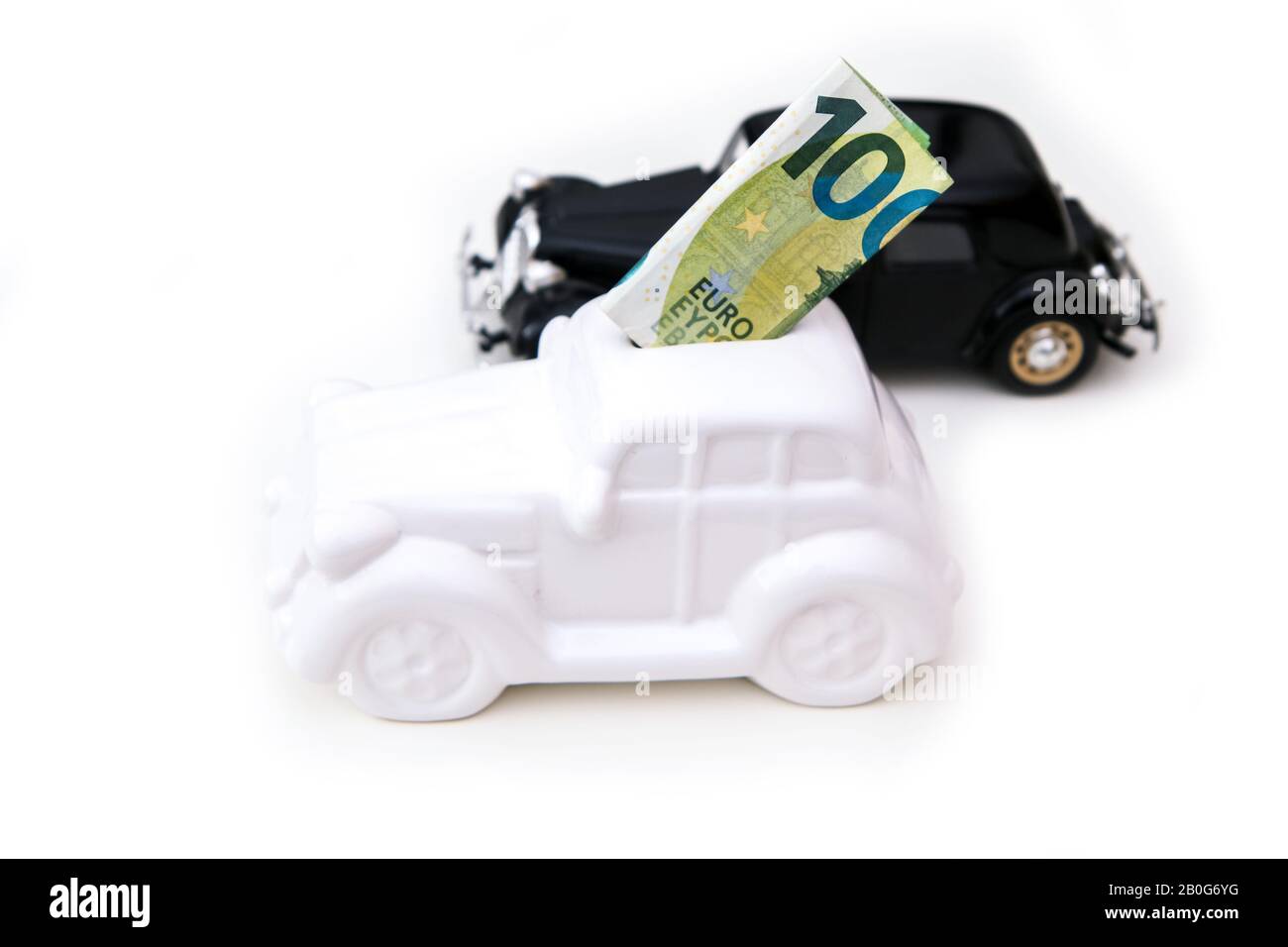 The ceramic car shaped money box with a banknote inside with model car ...