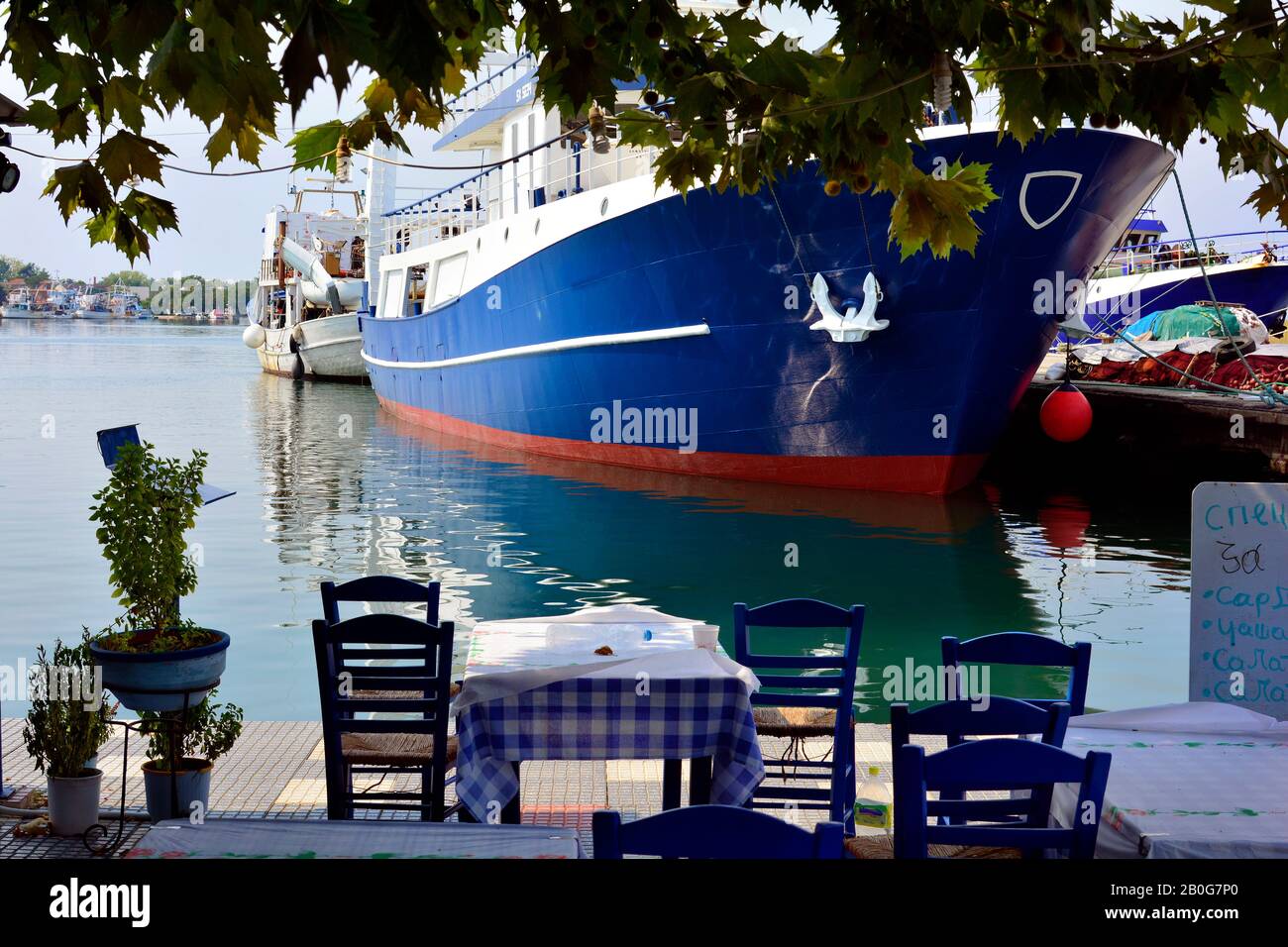 Greece, outside restaurant with ships in harbor Stock Photo - Alamy