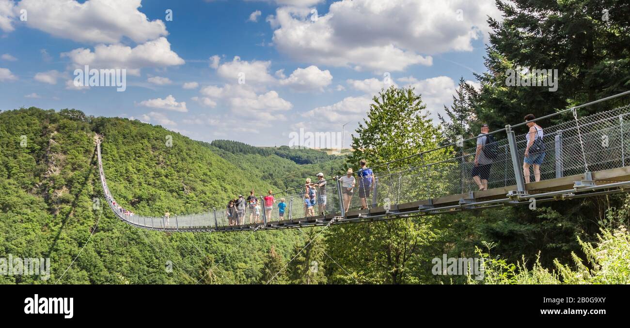 Panorama of tourists crossing the suspension bridge in Geierlay ...