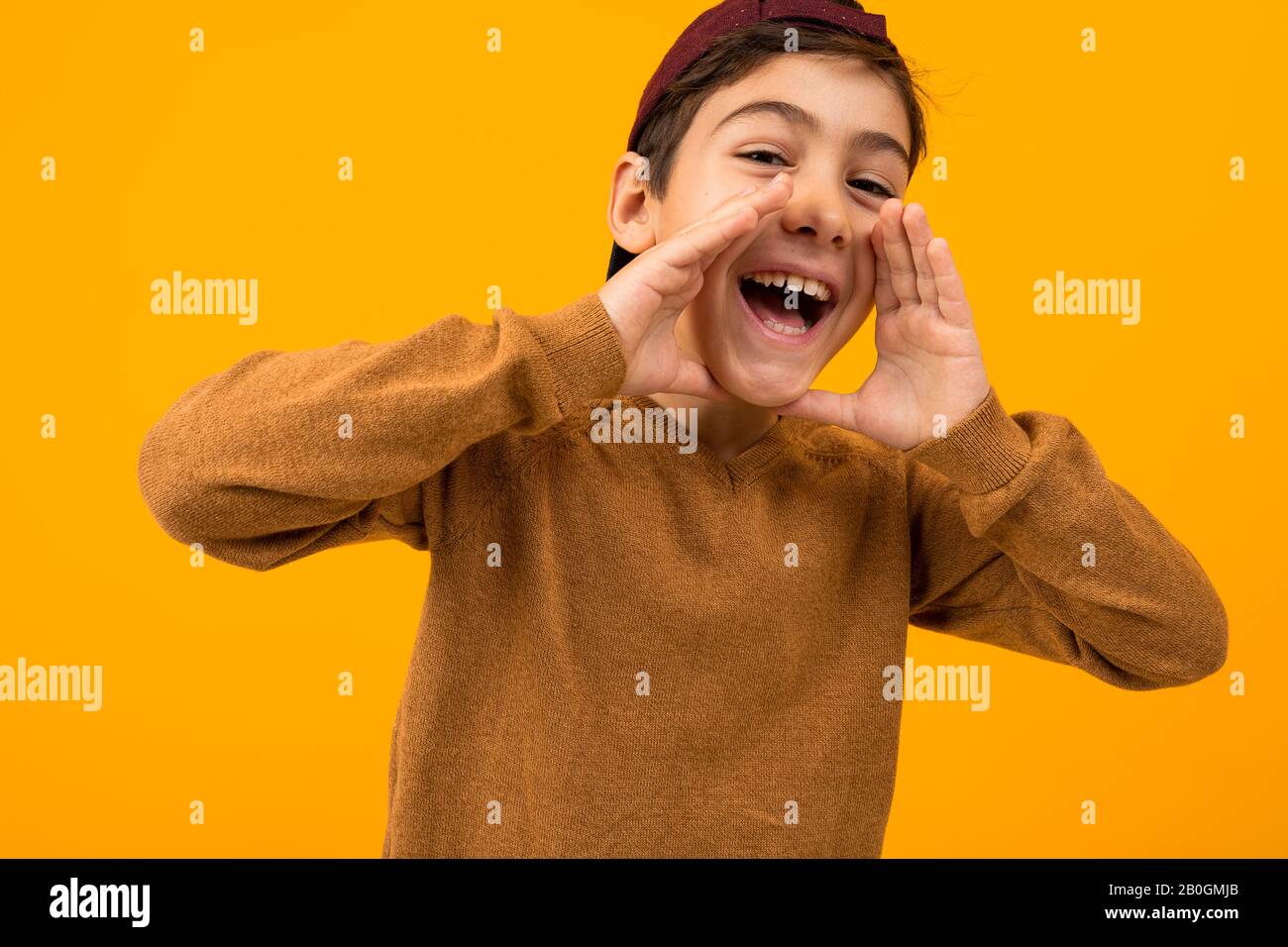 attractive boy screaming close-up on a yellow studio background Stock ...