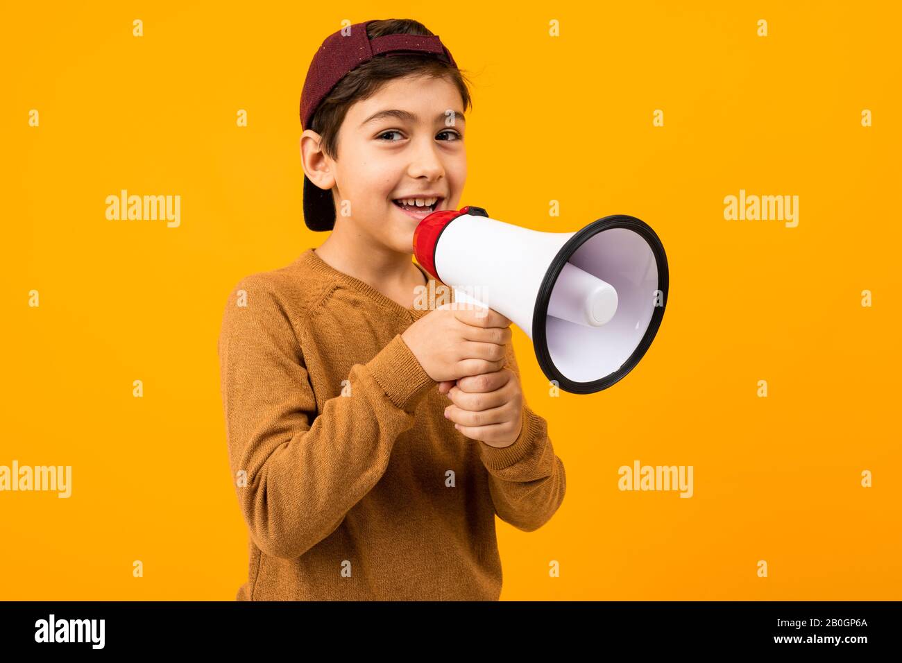attractive european boy with a megaphone in his hands for a poster on ...
