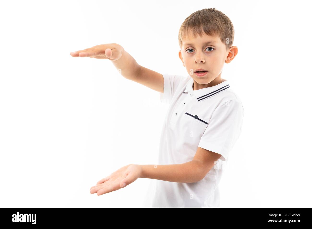 Young caucasian teenager shows something big on white background Stock ...