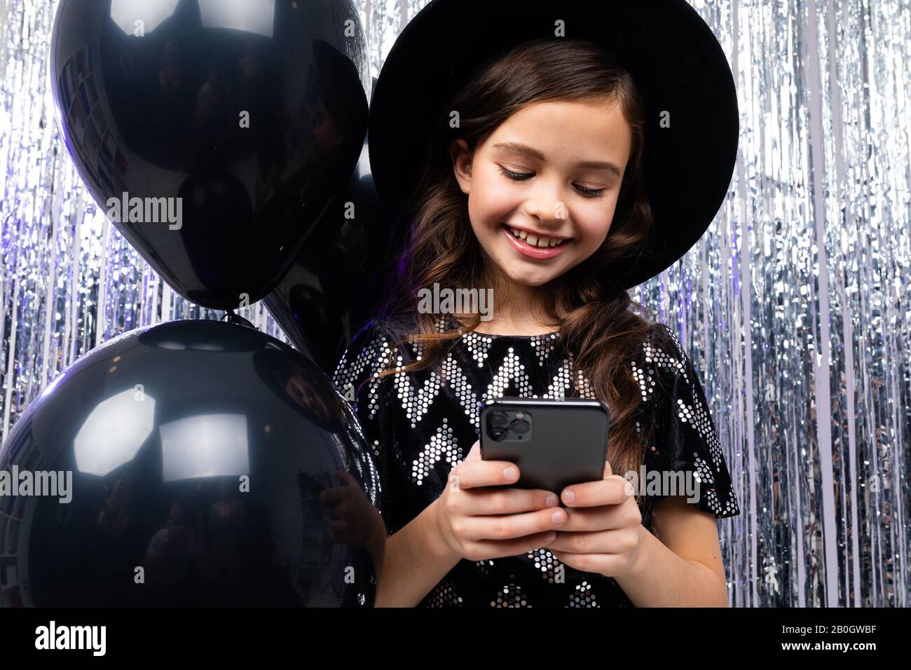 European teenage girl writes a message on the phone on his birthday on ...