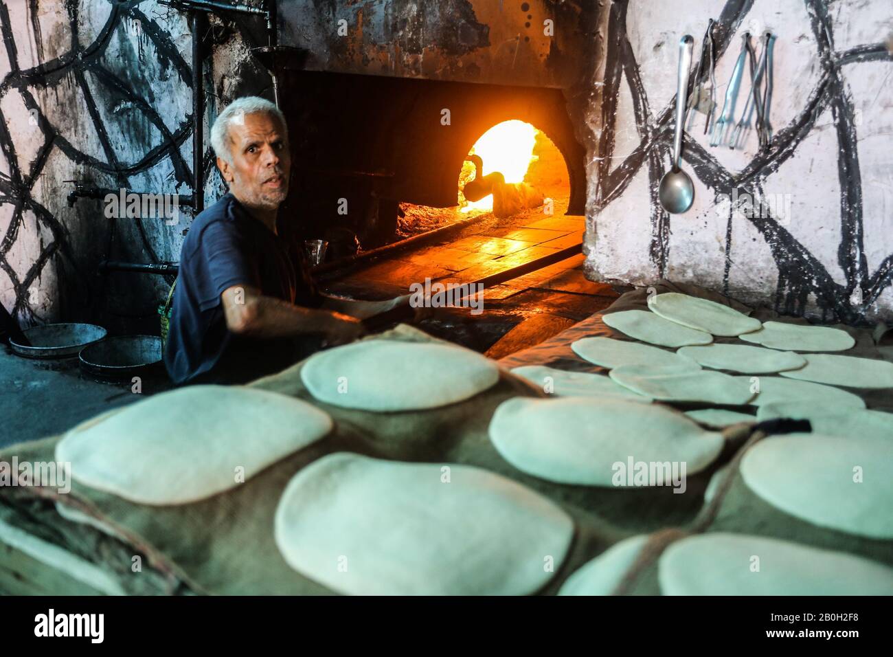 Palestinian man works in the only traditional bakery that stays working ...