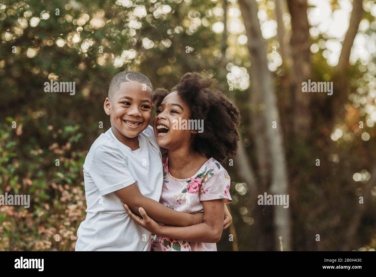 Close up portrait of brother and sister laughing at each other Stock ...