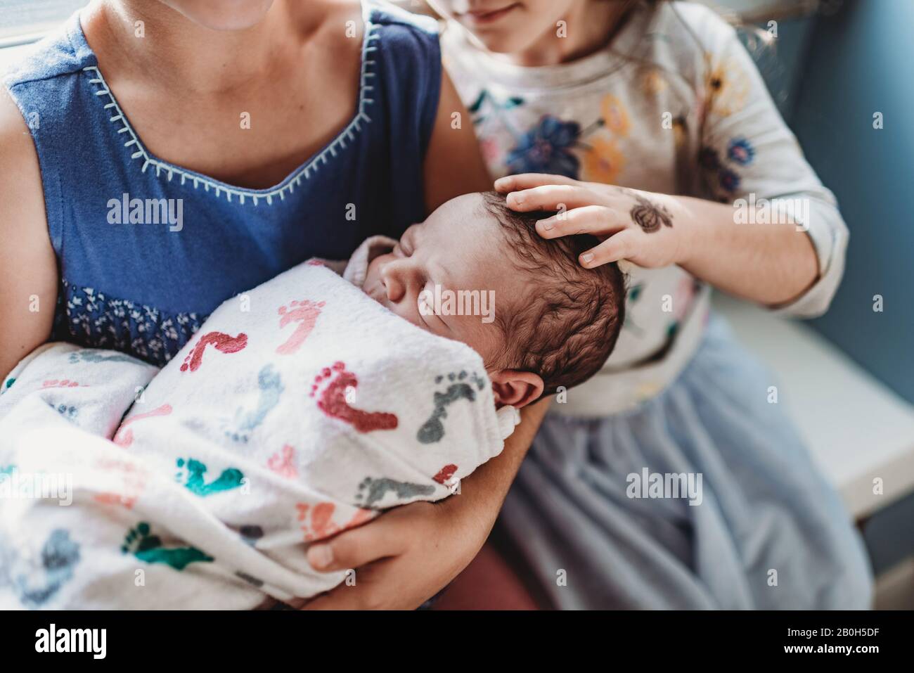 Boy cuddling baby brother hi-res stock photography and images - Alamy