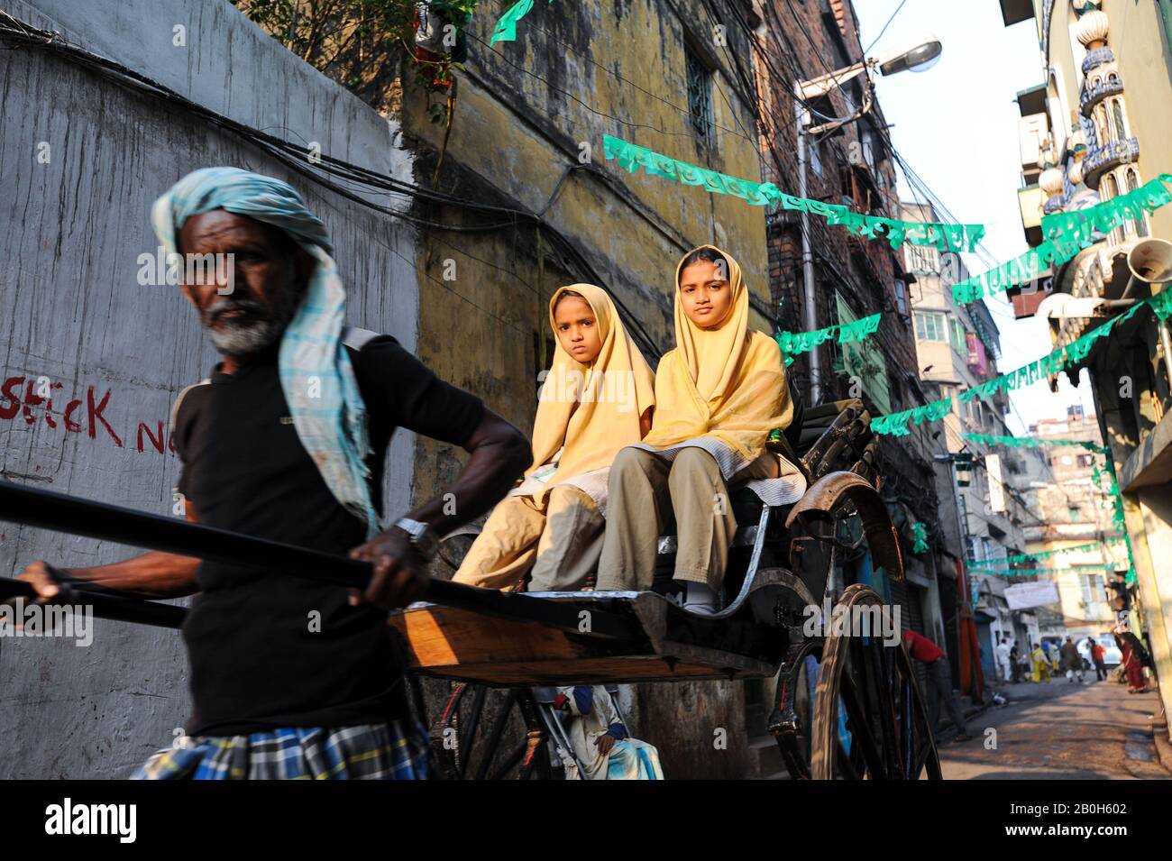 Indian man pulling rickshaw passenger hi-res stock photography and ...