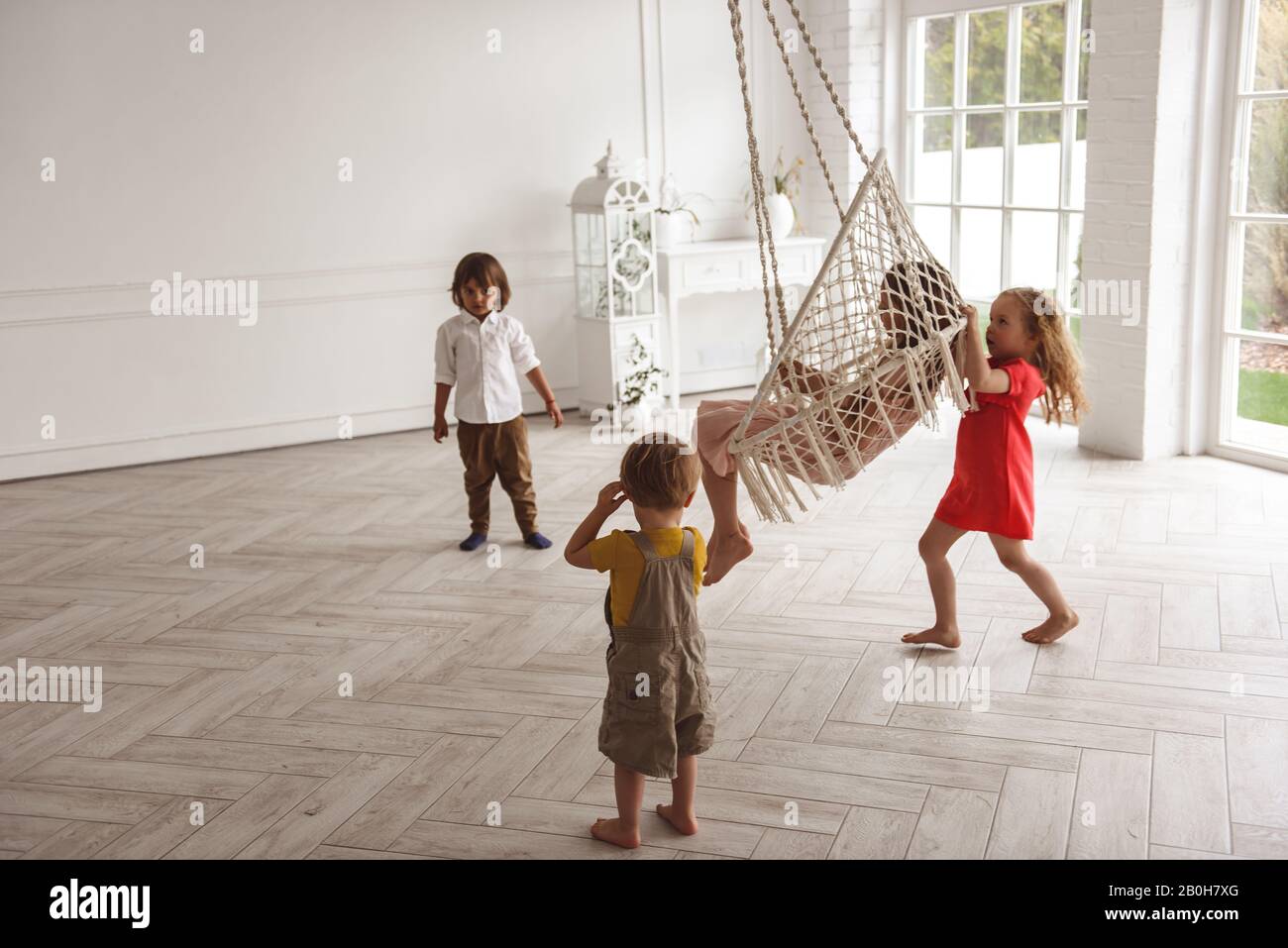 children swinging on swings for Easter Stock Photo - Alamy