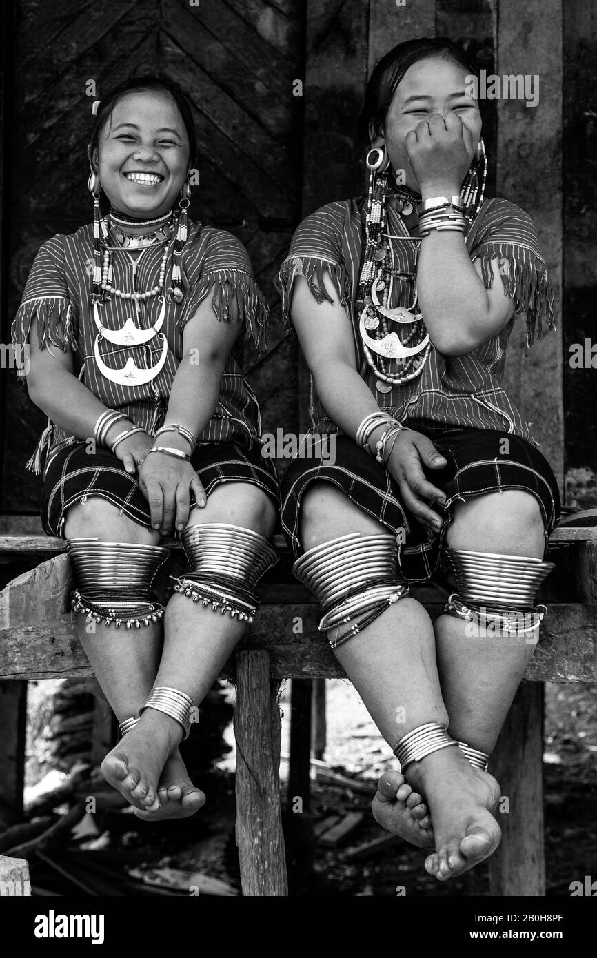 Two Young Women From The Kayaw Ethnic Group Sitting Down Outside Their ...