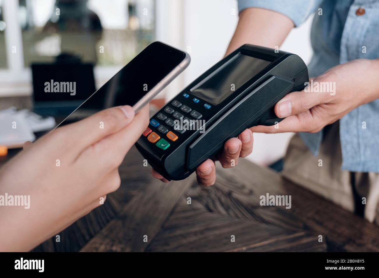 Paying with mobile phone. NFC payment technology Stock Photo - Alamy