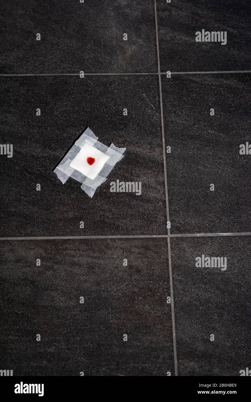 Bandage mesh with blood on grey tile floor. Top view Stock Photo - Alamy