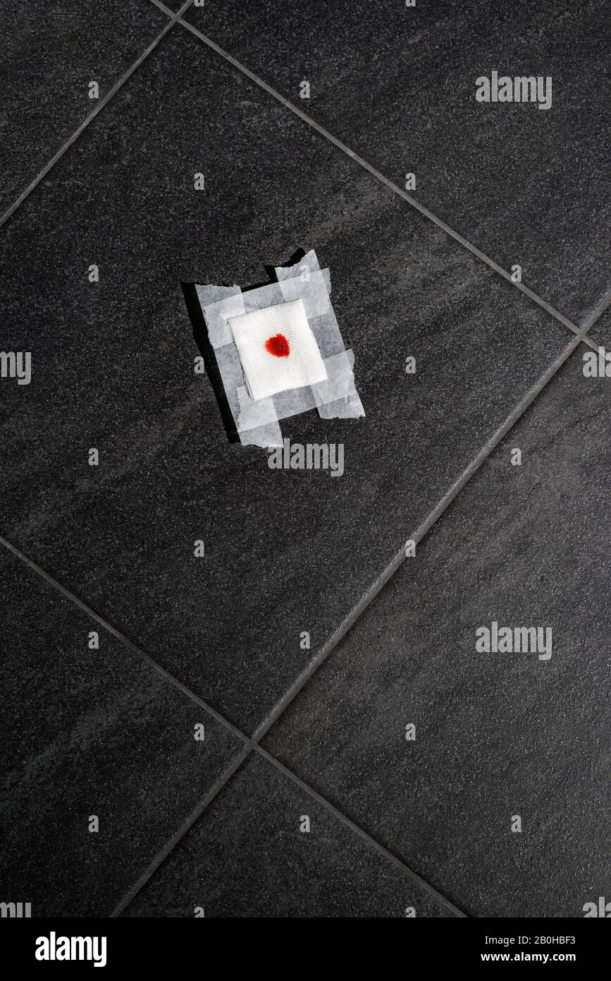 Bandage mesh with blood on grey tile floor. Top view Stock Photo - Alamy
