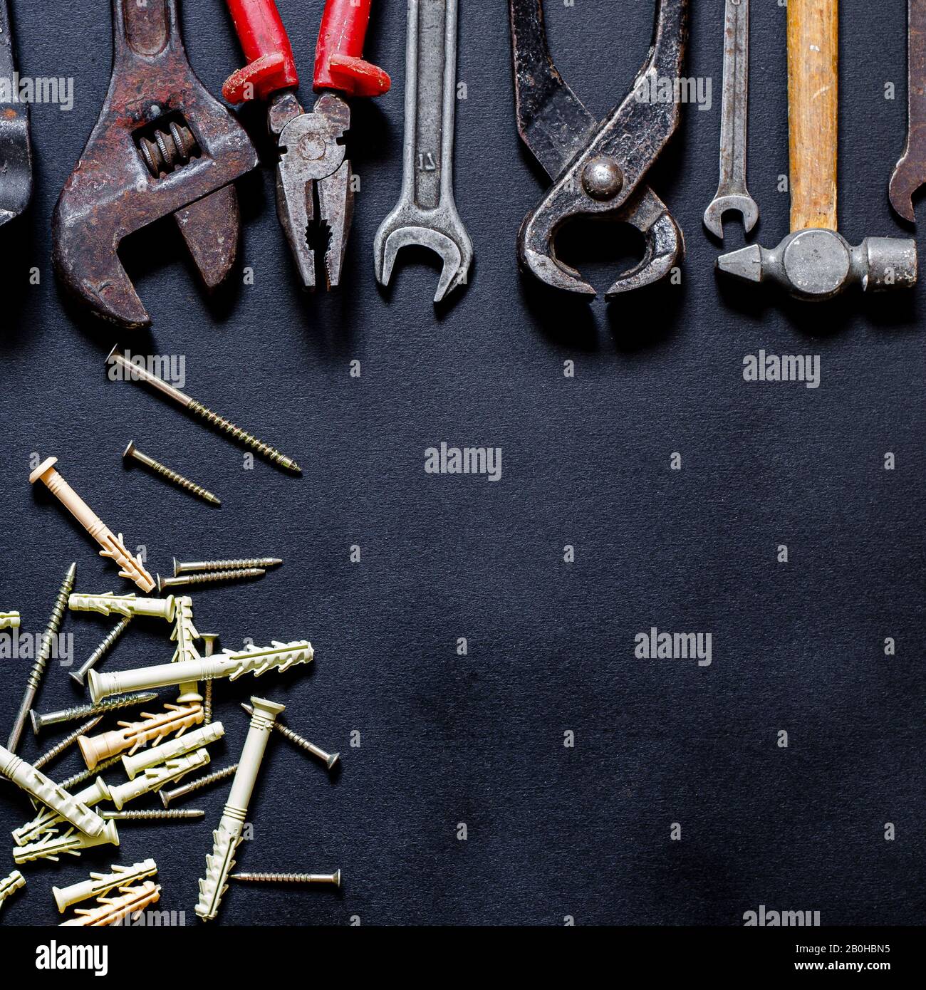 Construction worker tools on a dark background top view Stock Photo - Alamy