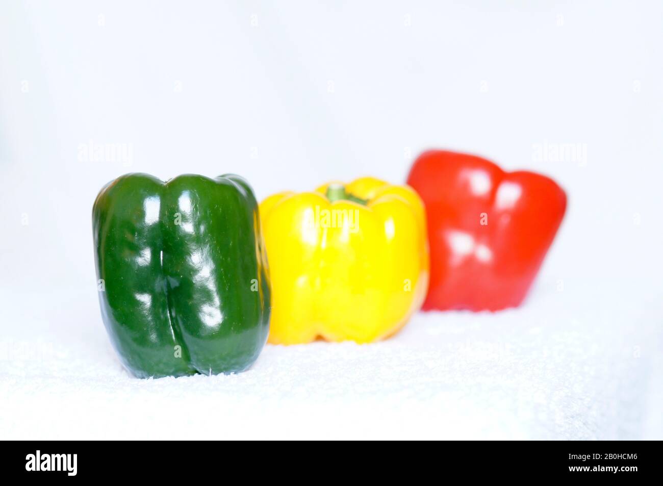 Mixed colour bell peppers against white background Stock Photo - Alamy