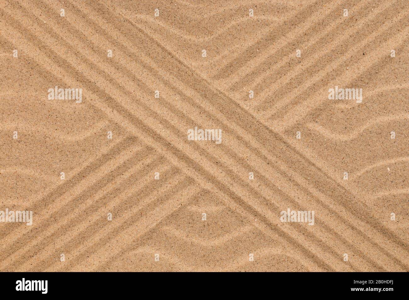 Cross lines and wavy sand lines. Texture of sand. Copy space. Top view ...