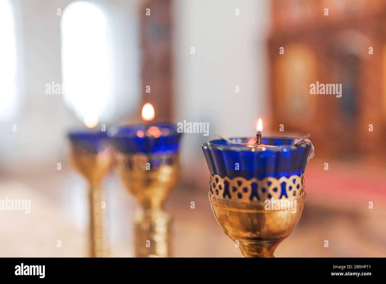Orthodox Church Lamp with lit Candle and Red Glass on the icon ...