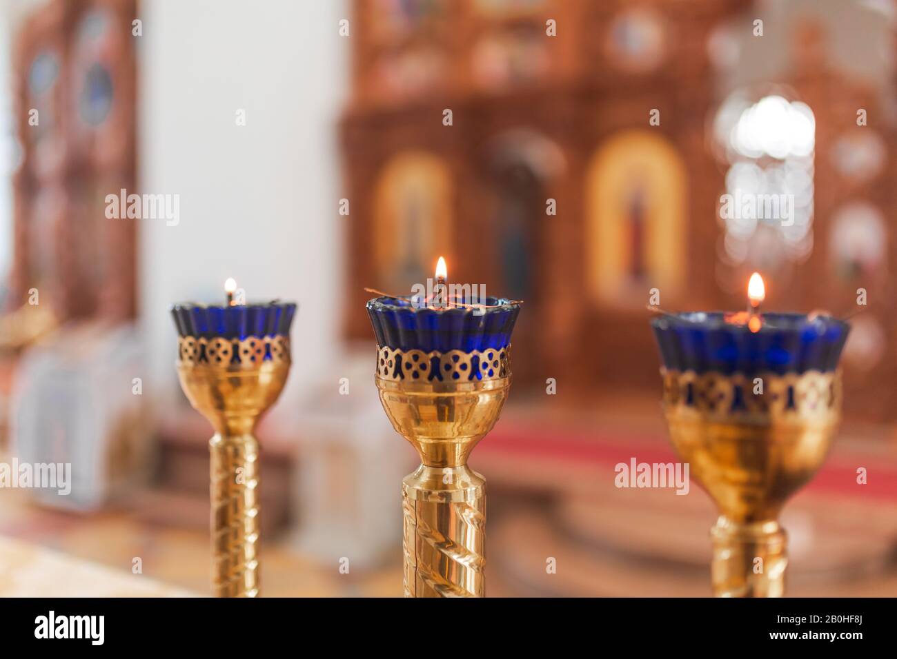 Orthodox Church Lamp with lit Candle and Red Glass on the icon ...