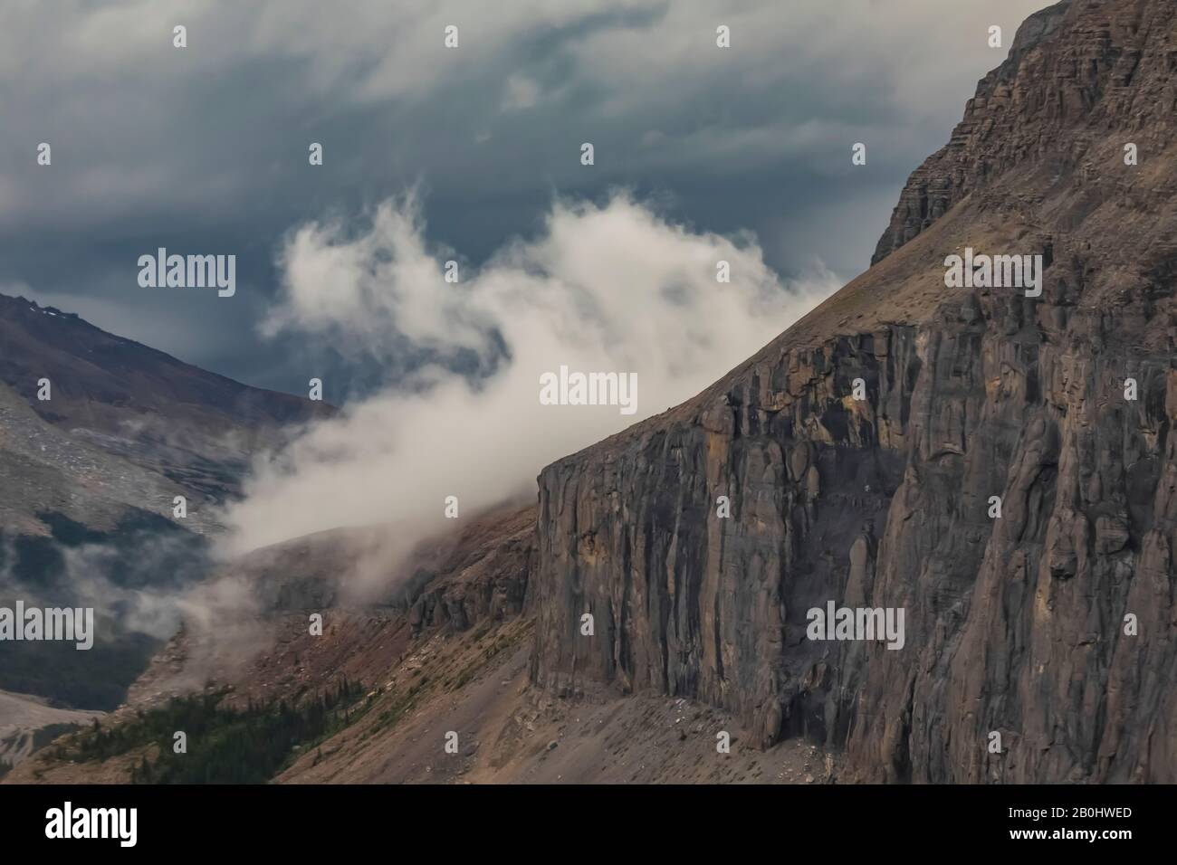 Helicopter-hiking flight past cliffs of Mt. Robson into the backcountry ...
