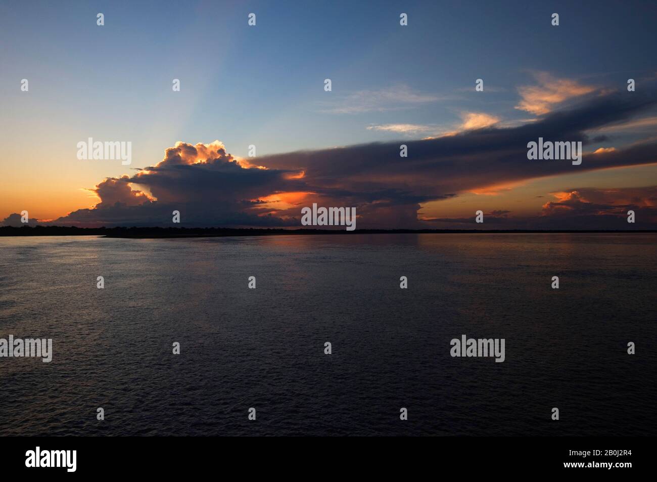 PERU, AMAZON RIVER, CUMULUS CLOUDS AT SUNSET Stock Photo - Alamy