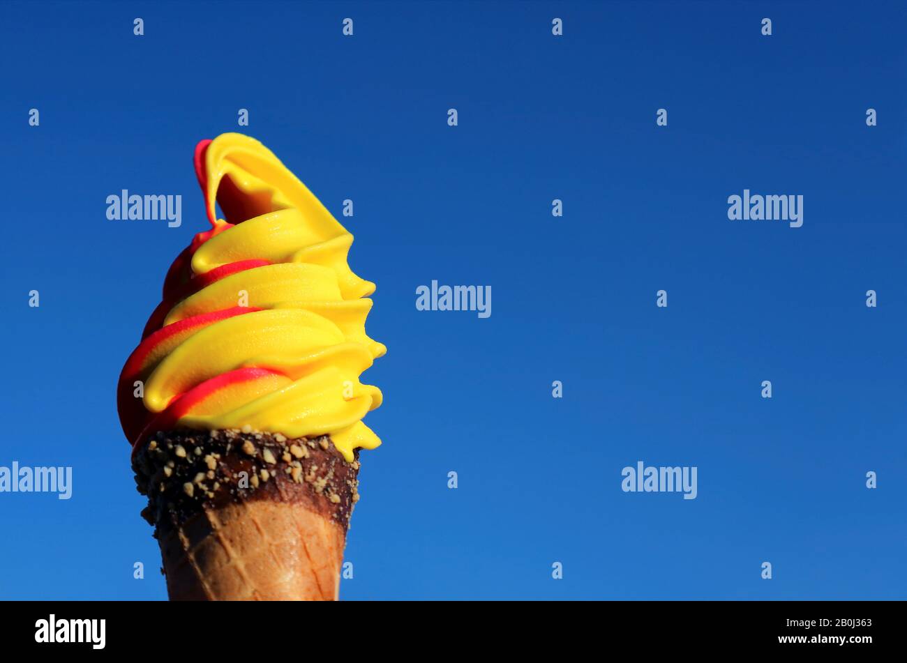 Vivid Yellow Banana with Raspberry Soft Serve Ice Cream Cone Against ...