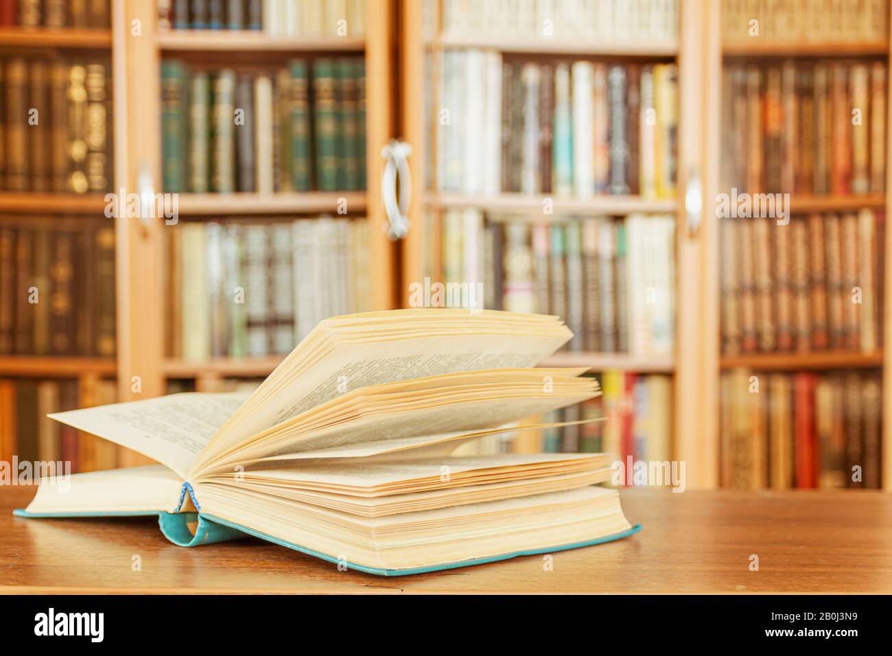 The open book is on the table in the background of the library Stock ...