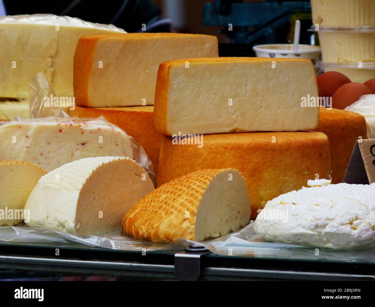arious types of delicious large cut round soft cheese pieces in yellow ...