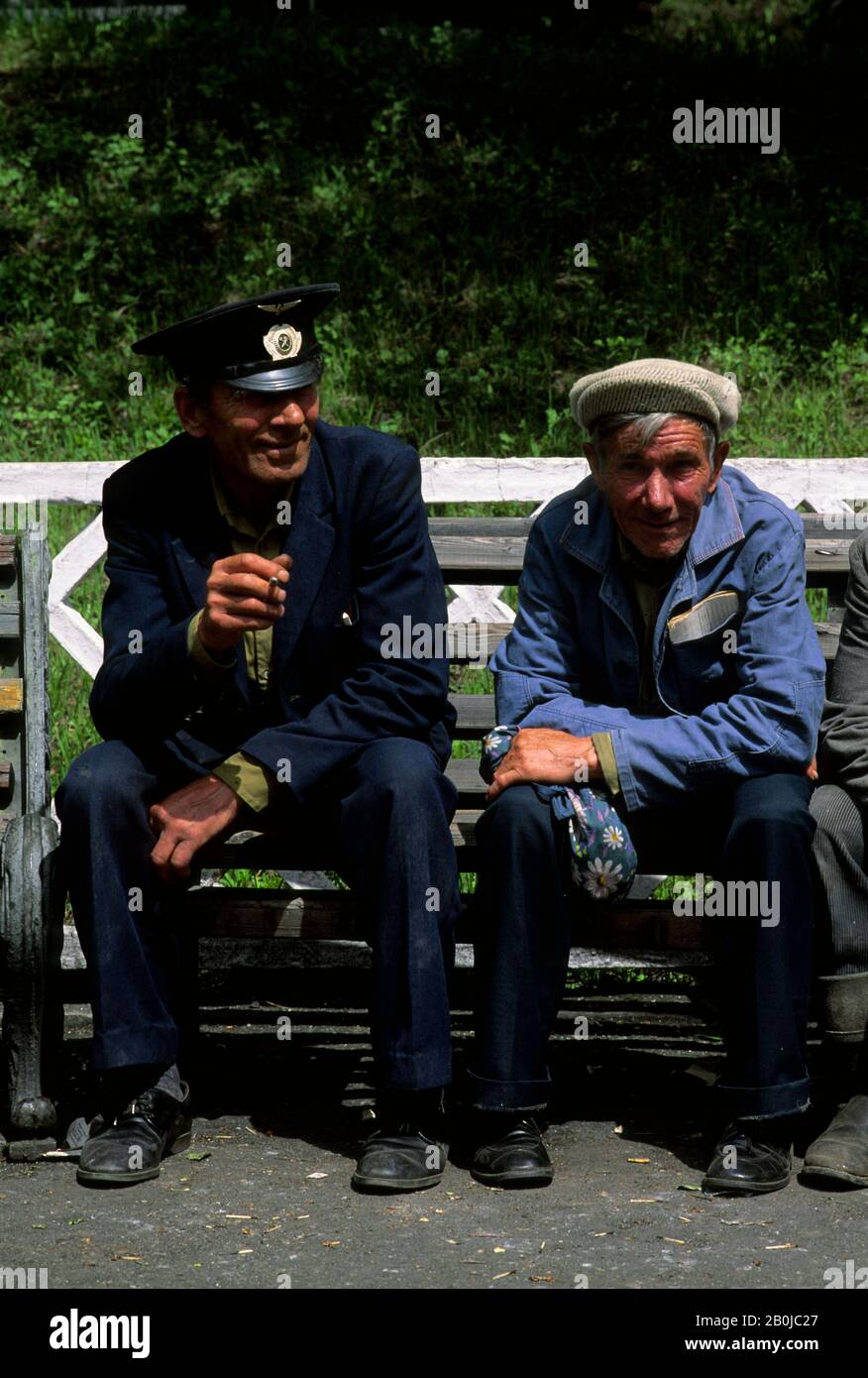 RUSSIA, SIBERIA URUSCHA, TRAIN STATION, MEN SITTING ON BENCH Stock ...
