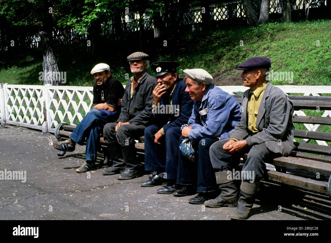 RUSSIA, SIBERIA URUSCHA, TRAIN STATION, MEN SITTING ON BENCH Stock ...