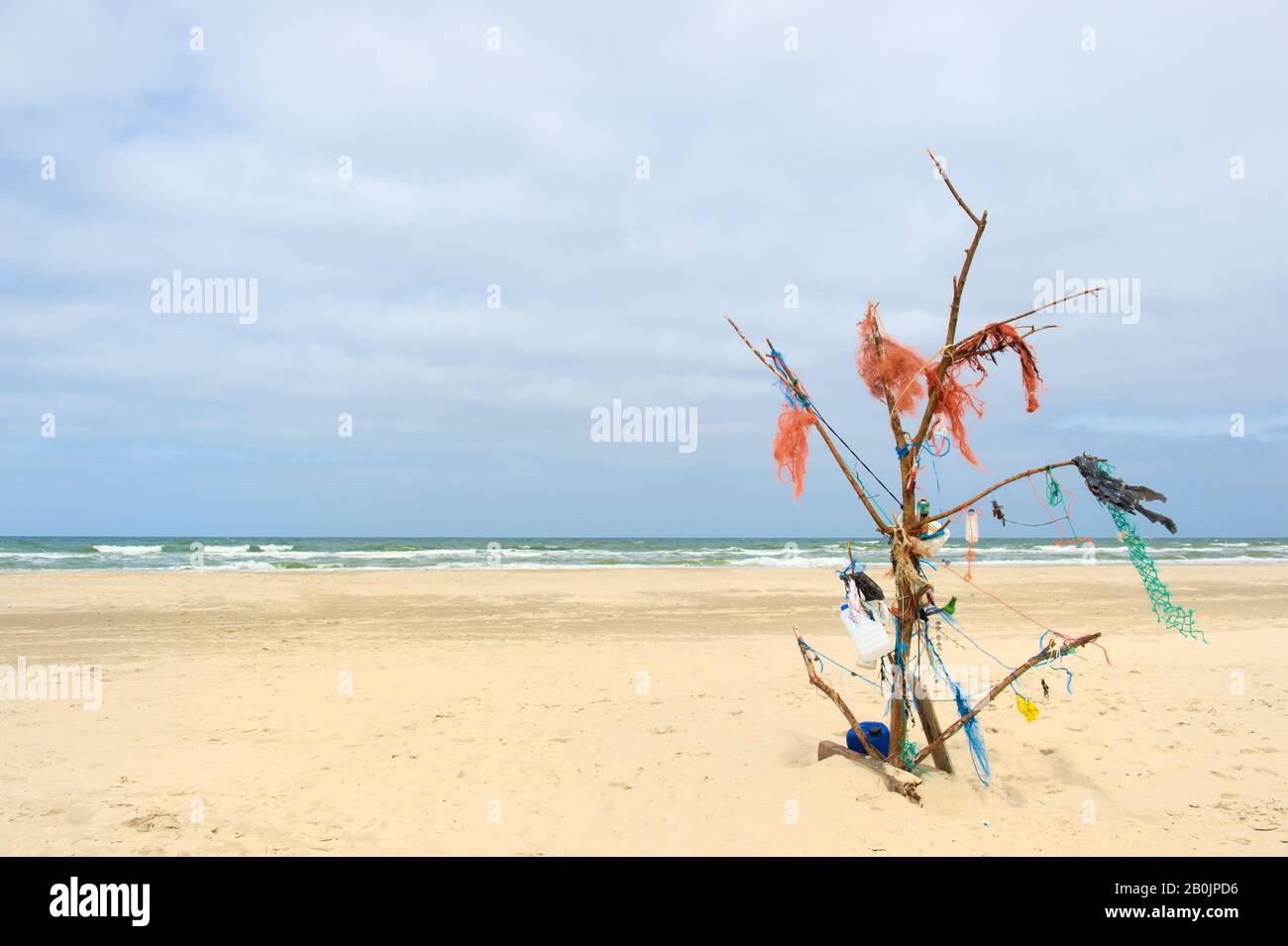 Landscape empty beach with tree made from rubbish at Dutch island ...