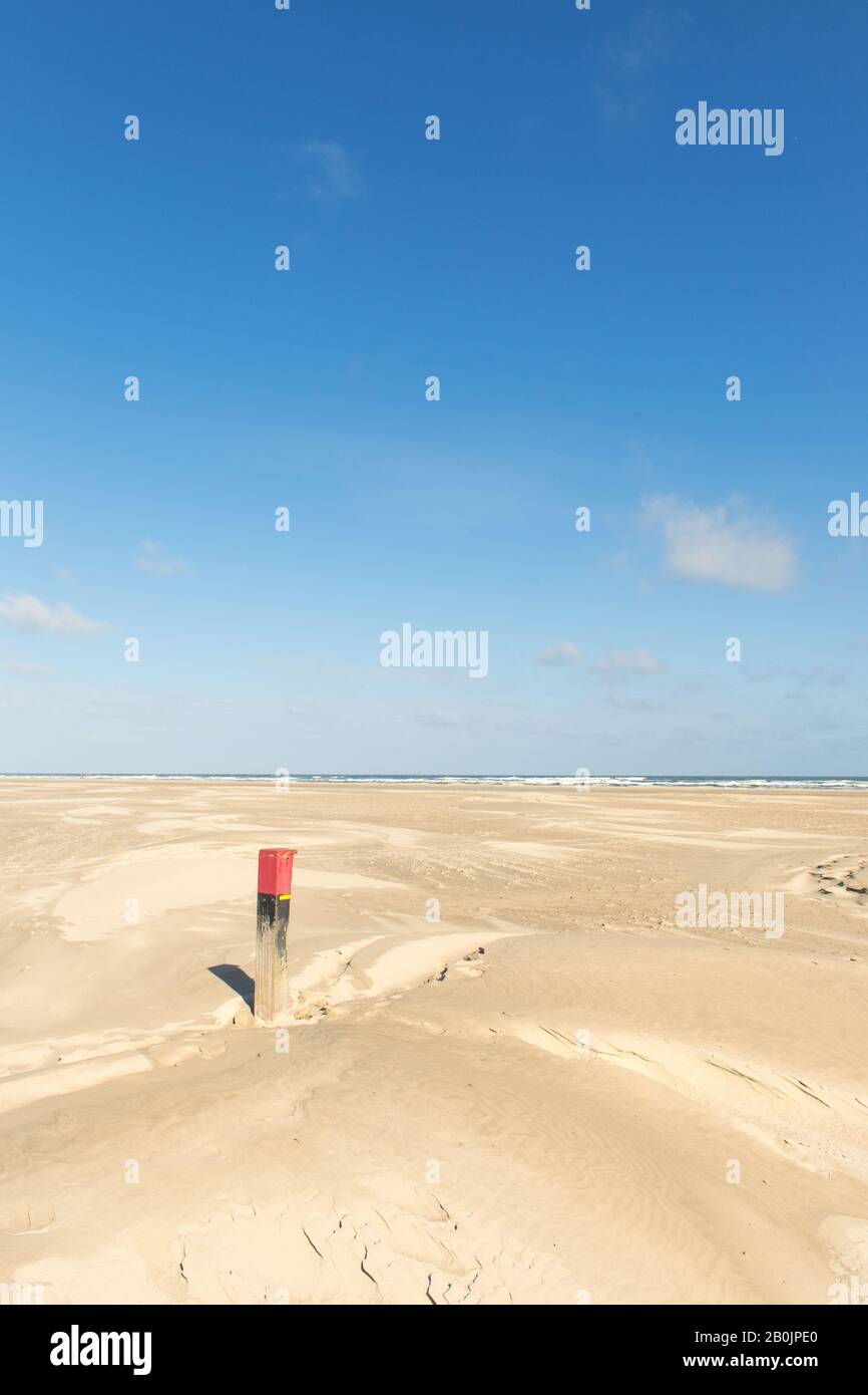 Red wooden pole at the beach Stock Photo - Alamy