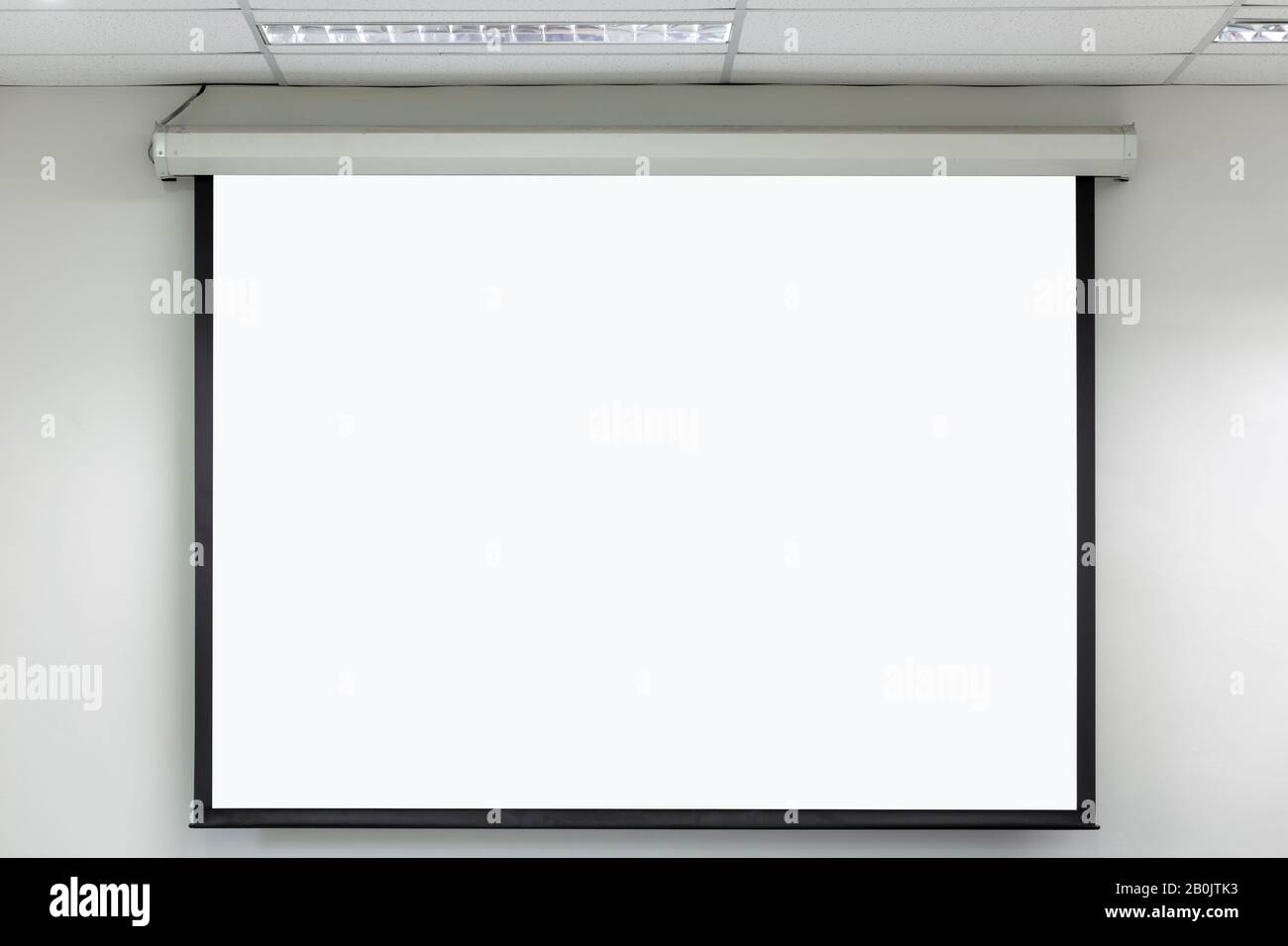 Front view of lecture room with empty white projector screen Stock Photo - Alamy