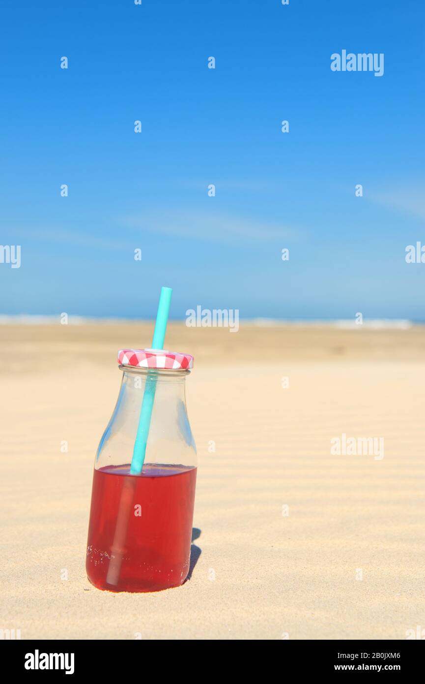 Bottles lemonade at the empty beach Stock Photo - Alamy