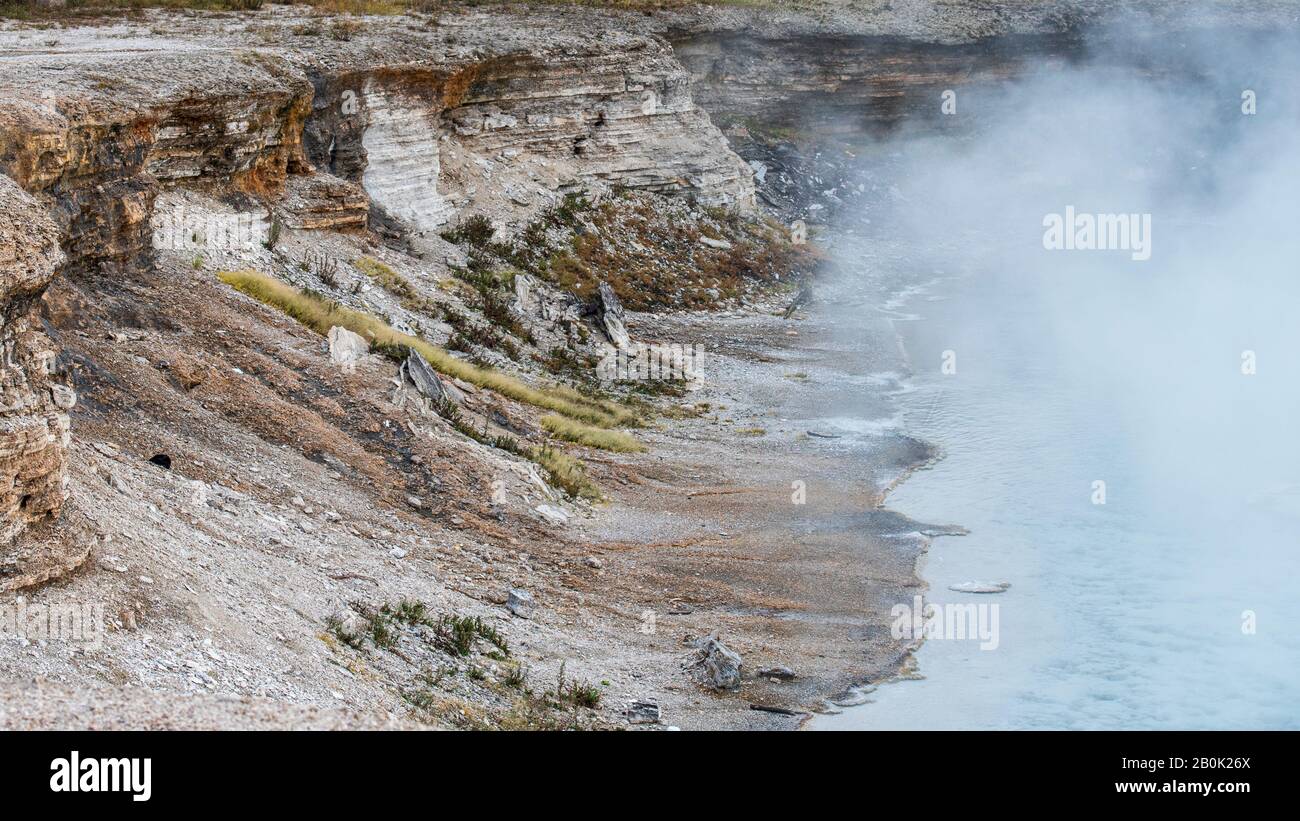 Fog rolling in off of water towards shoreline and cliffs Stock Photo ...