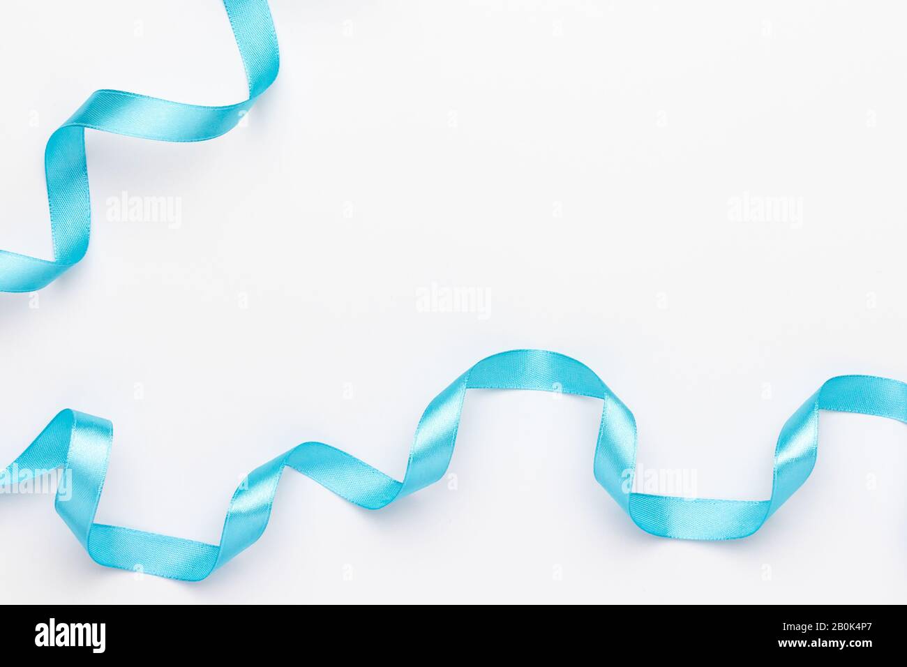 A light blue ribbon on a white background Stock Photo - Alamy