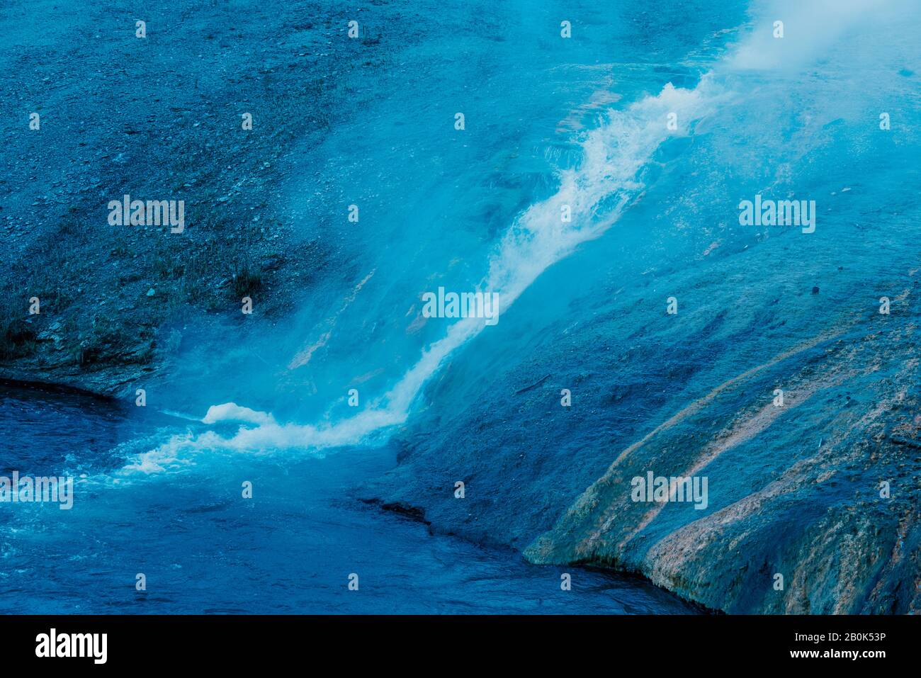 Icy cold water running down river banks into river Stock Photo - Alamy