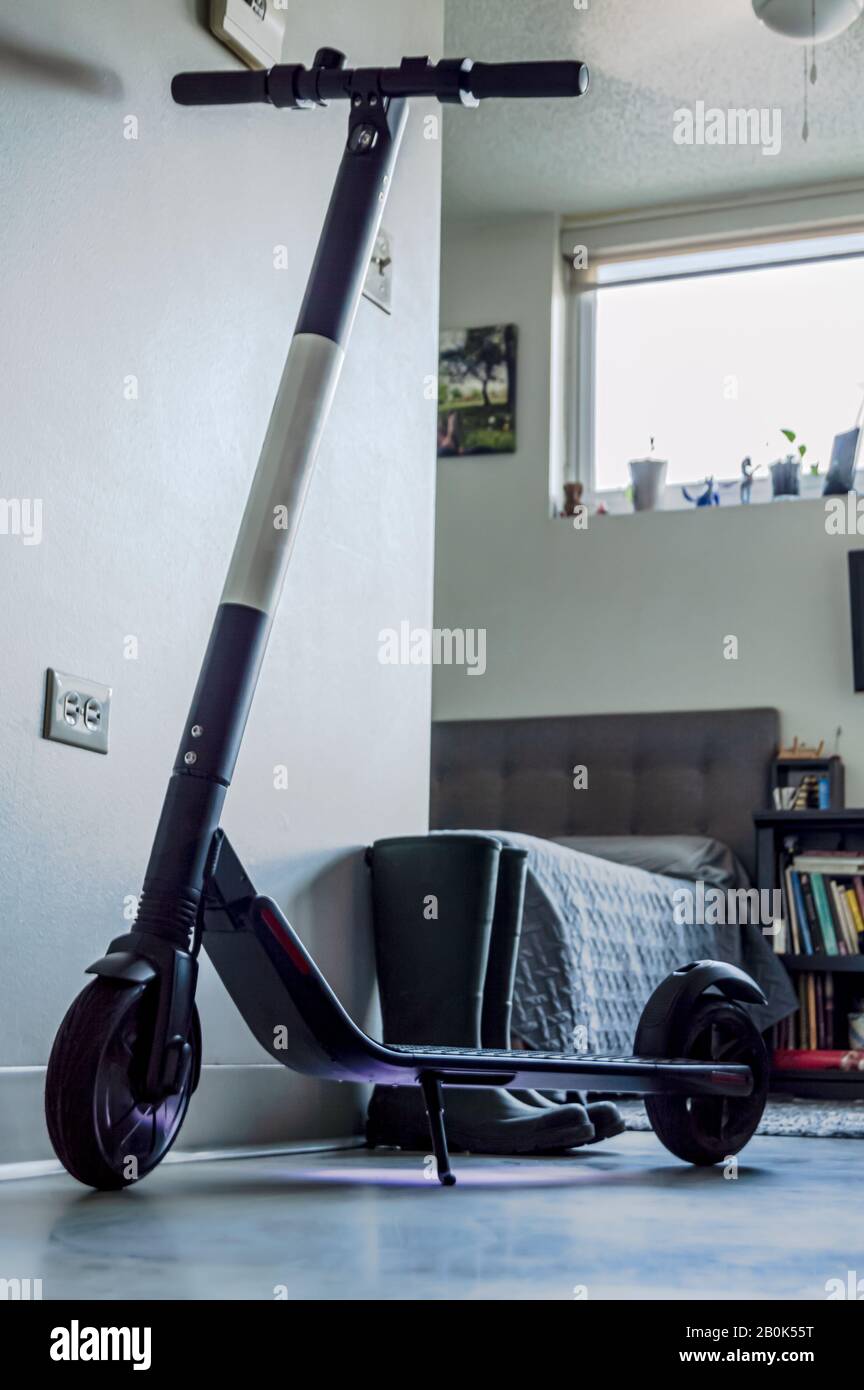Full view of an electric scooter that is parked indoors Stock Photo - Alamy