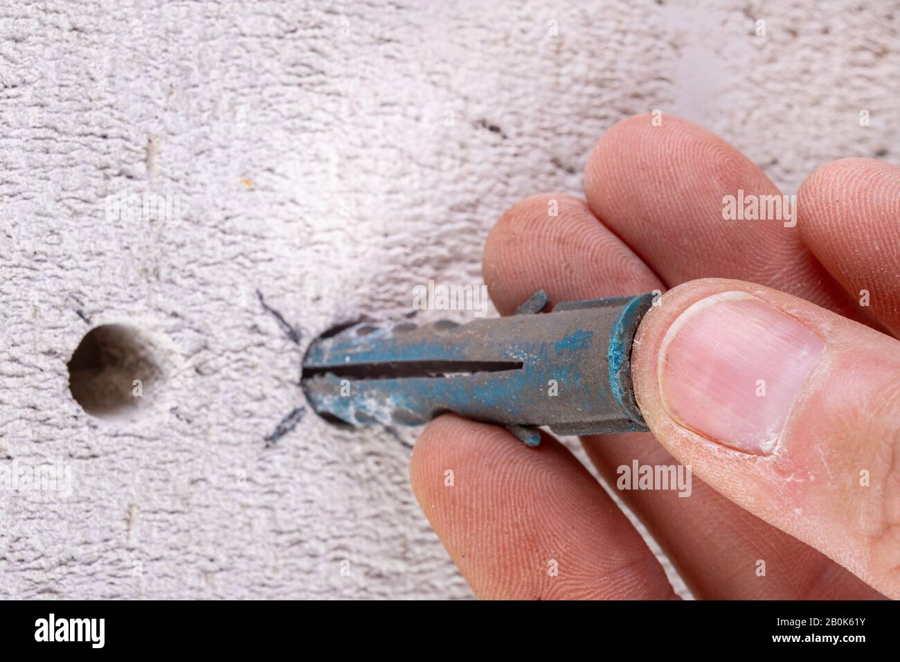 Hole in the wall, screw and dowel for fixing in concrete. Wall mounting ...