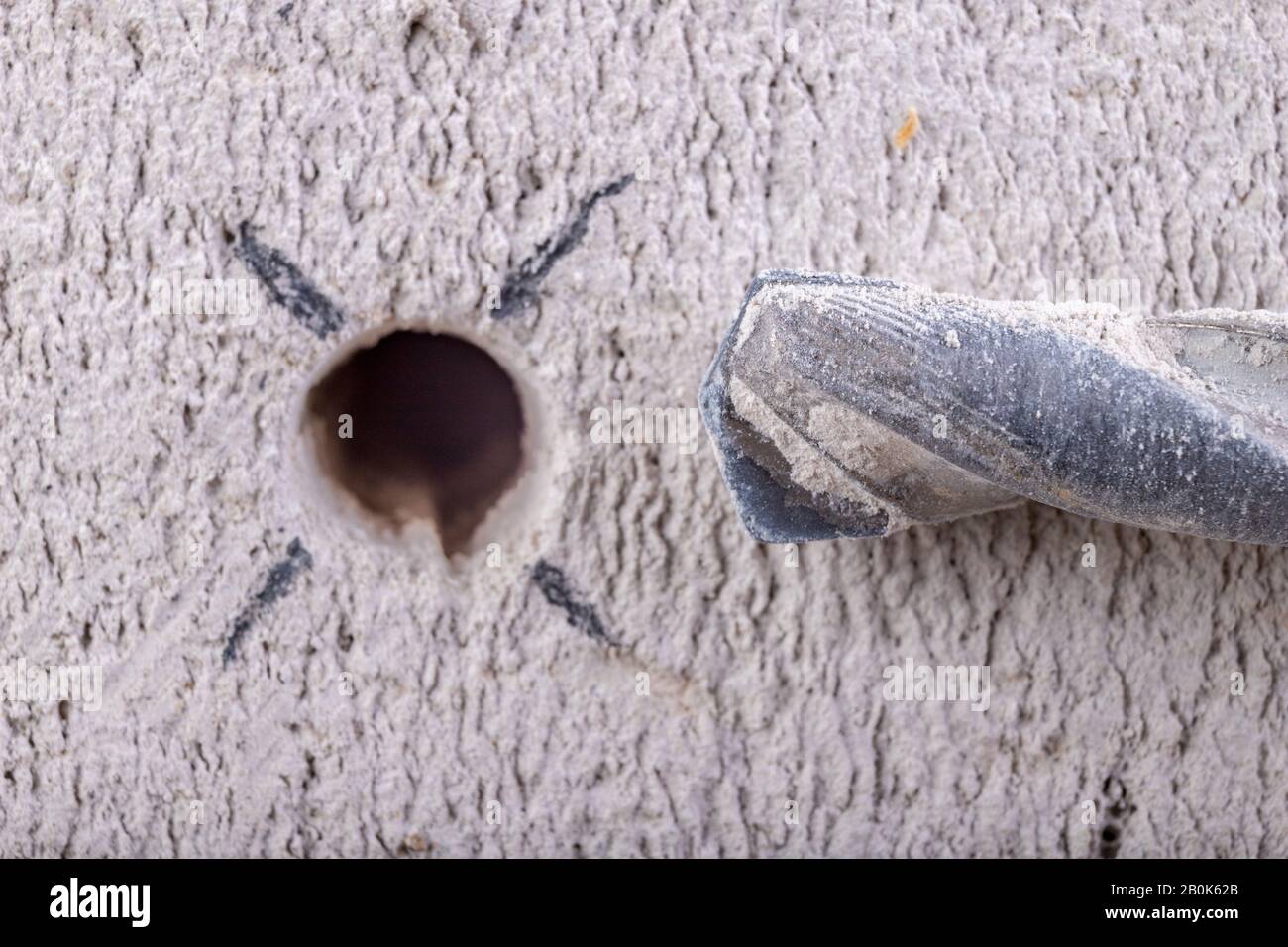 Holes in the wall and shovel drill. Construction works in the apartment ...